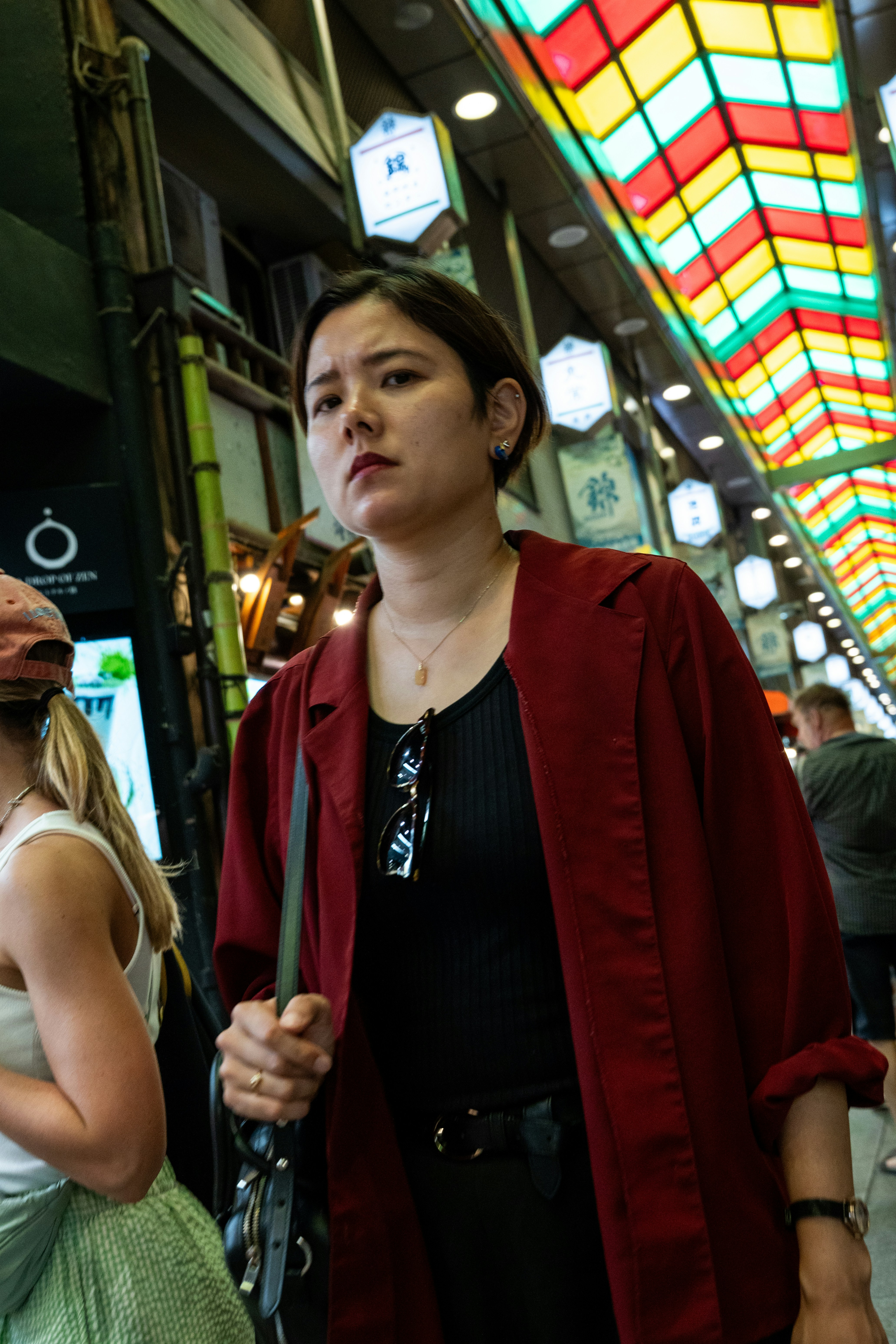 Urban Neon Portrait: A String of Colors in a Market Corridor