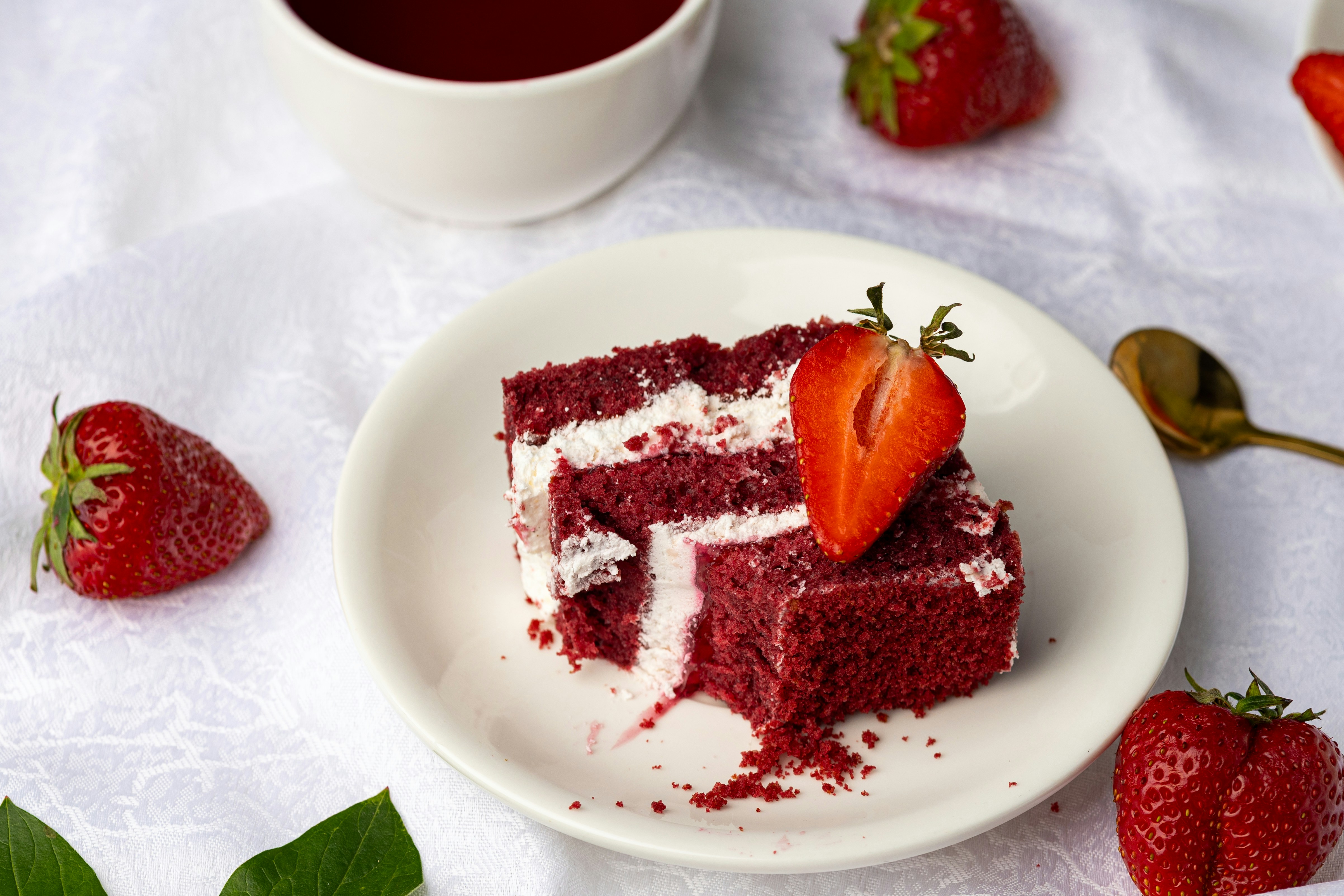 Ruby Slice on White Plate: Strawberry Ganache under a Blanket of Powdered Sugar