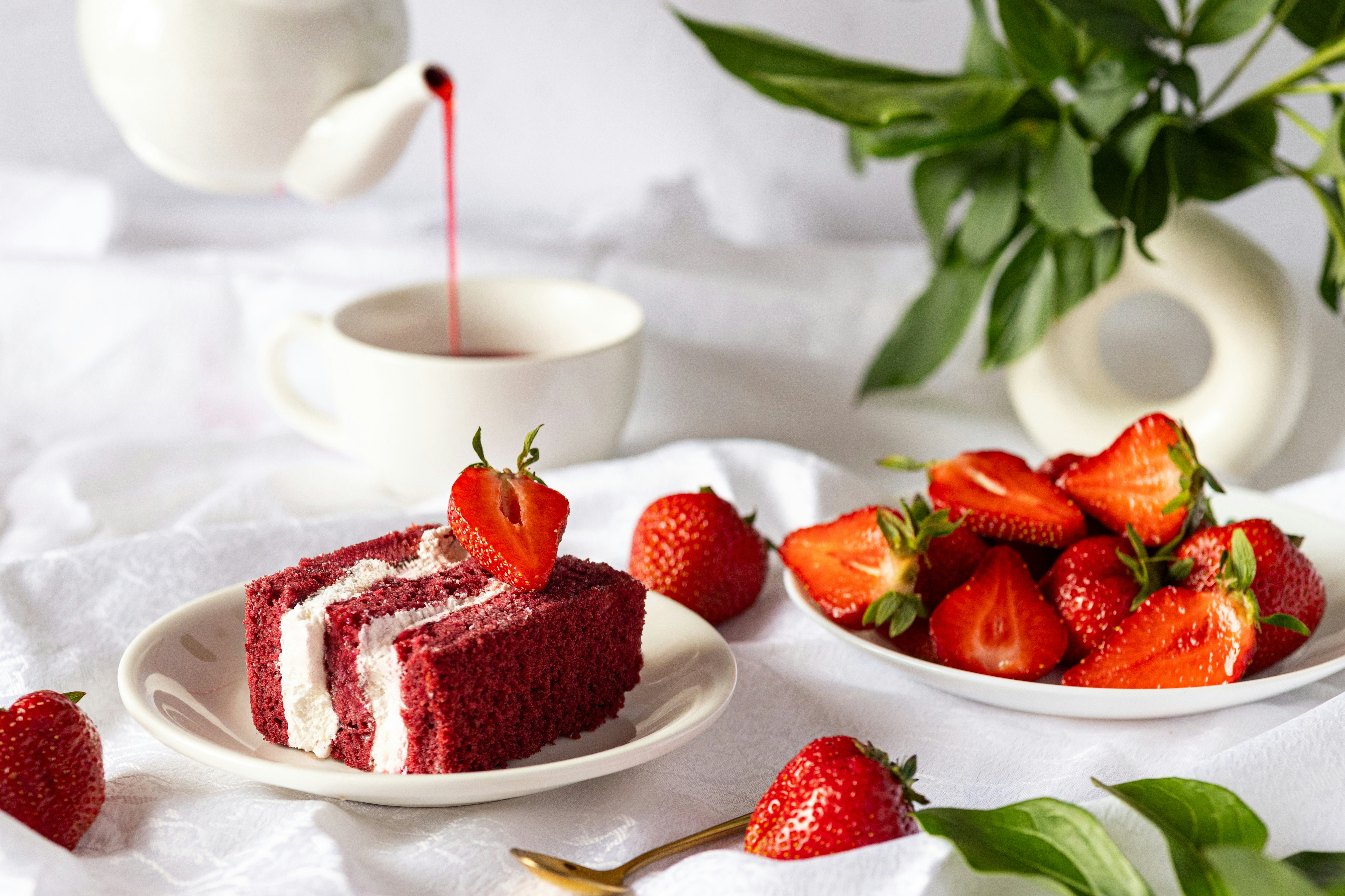 Strawberry Jubilee: Velvet Red Cake Chunks and Fresh Berries on a White Table