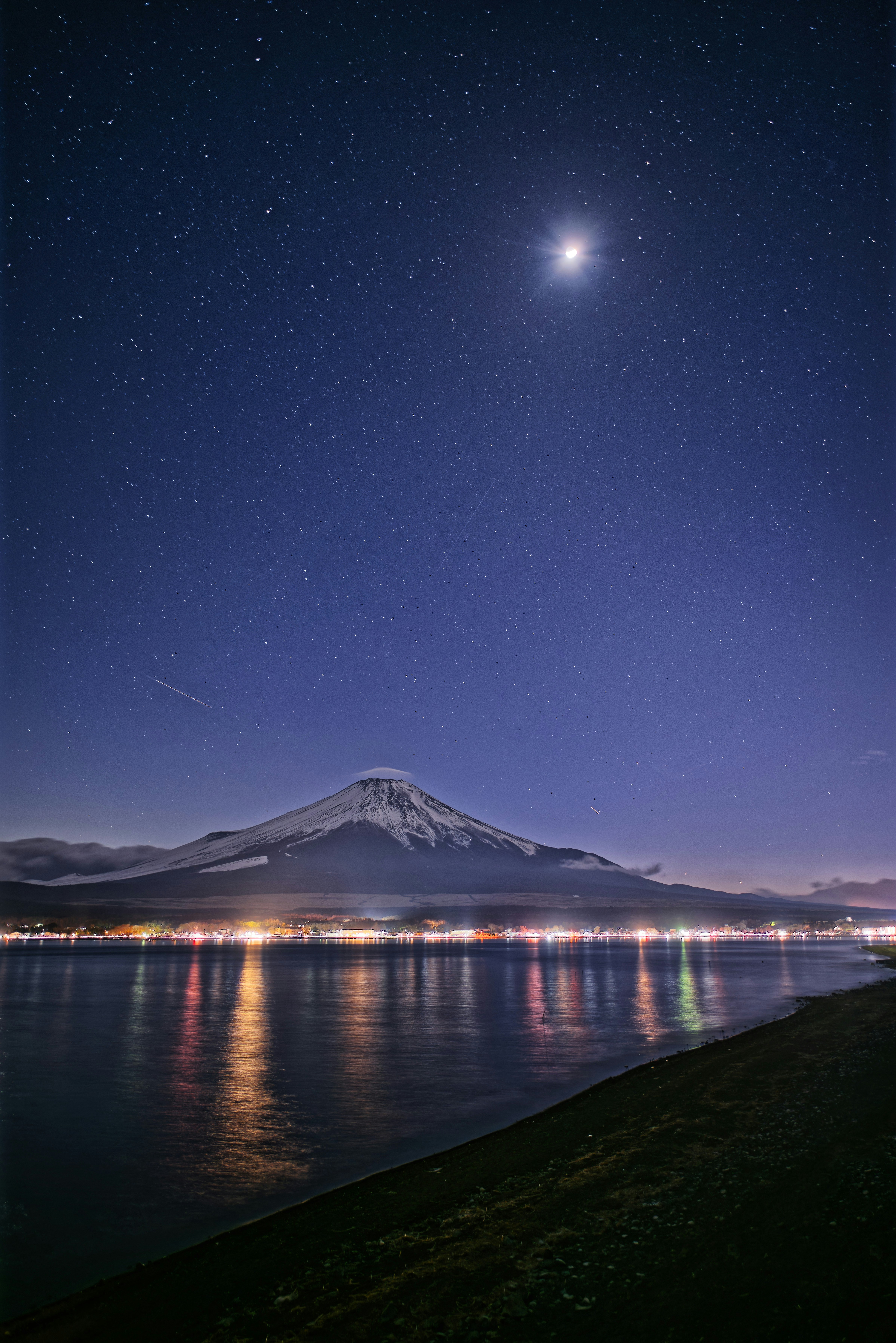 Moonlit Snow-Volcano Over a Quiet Fjord
