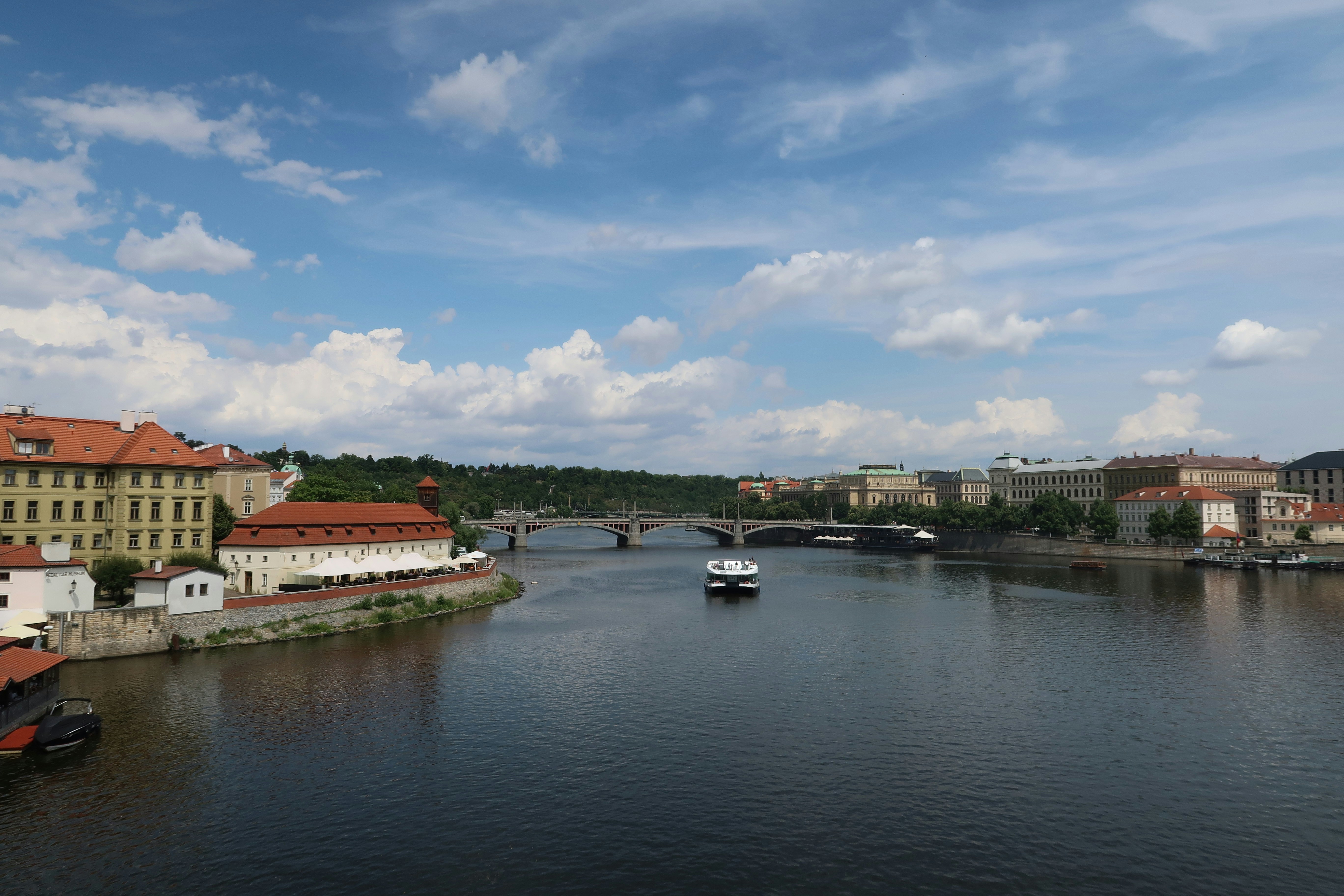 Stonebridge Quiet: Boats drift along a sunlit Vltava