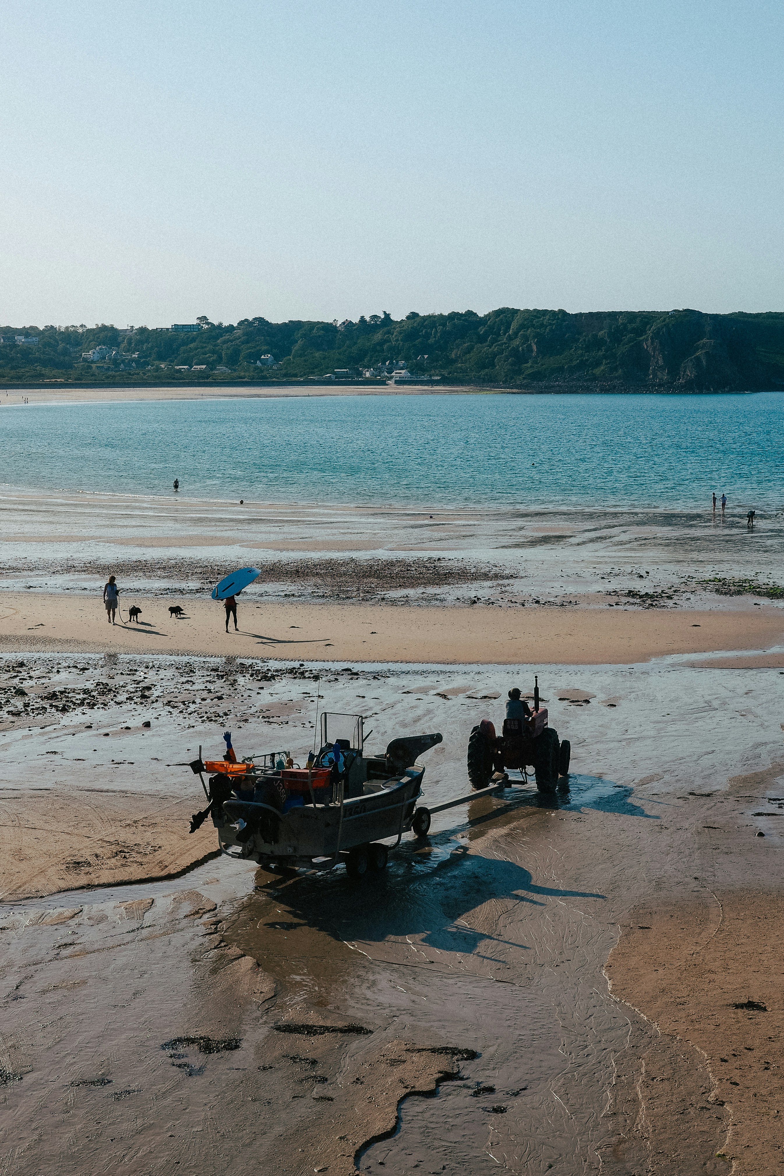 Dockside Tranquility: Tractor and Boat on a Shallow Tide