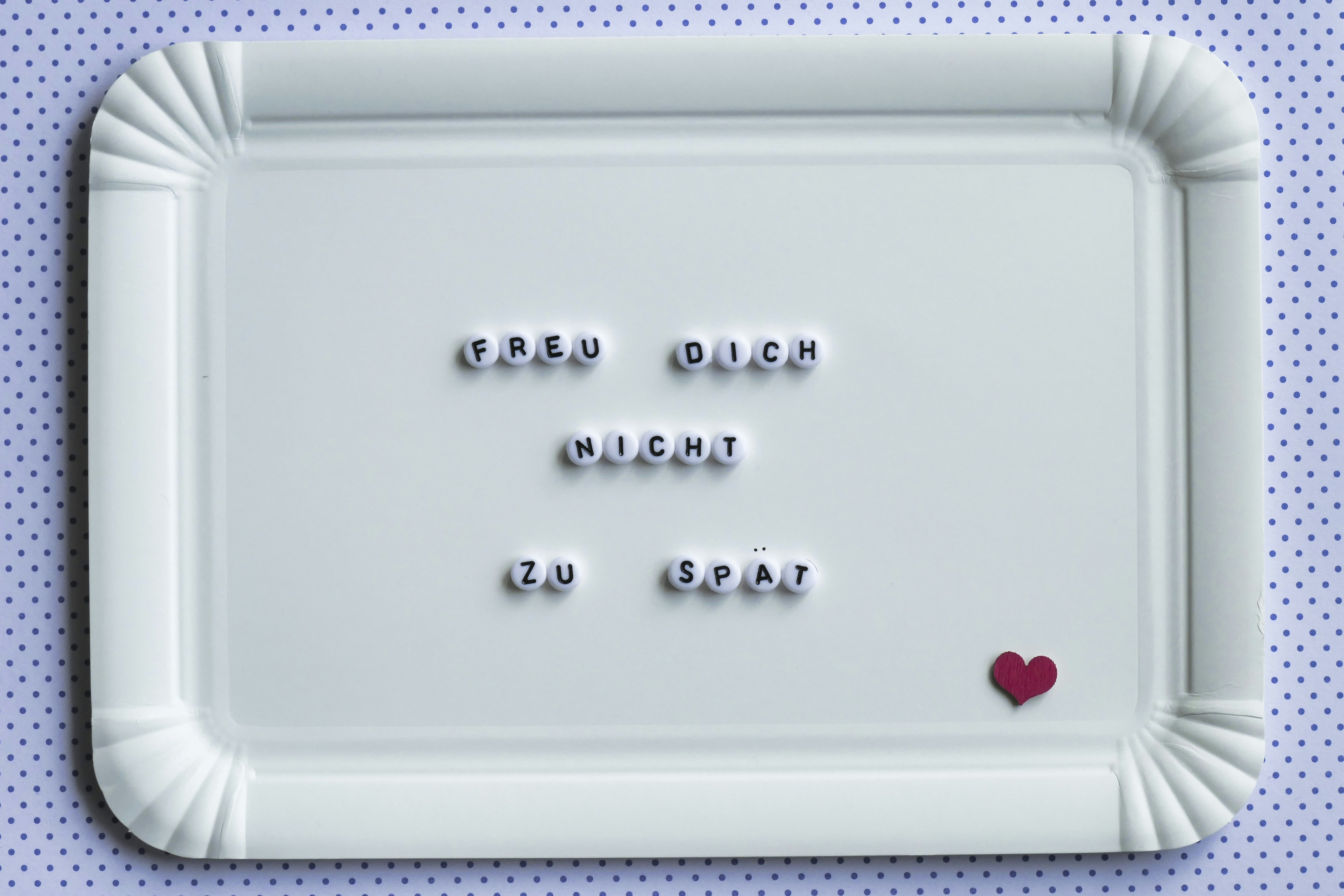 Tiny Letters, Quiet Message: A Tray of Words on White