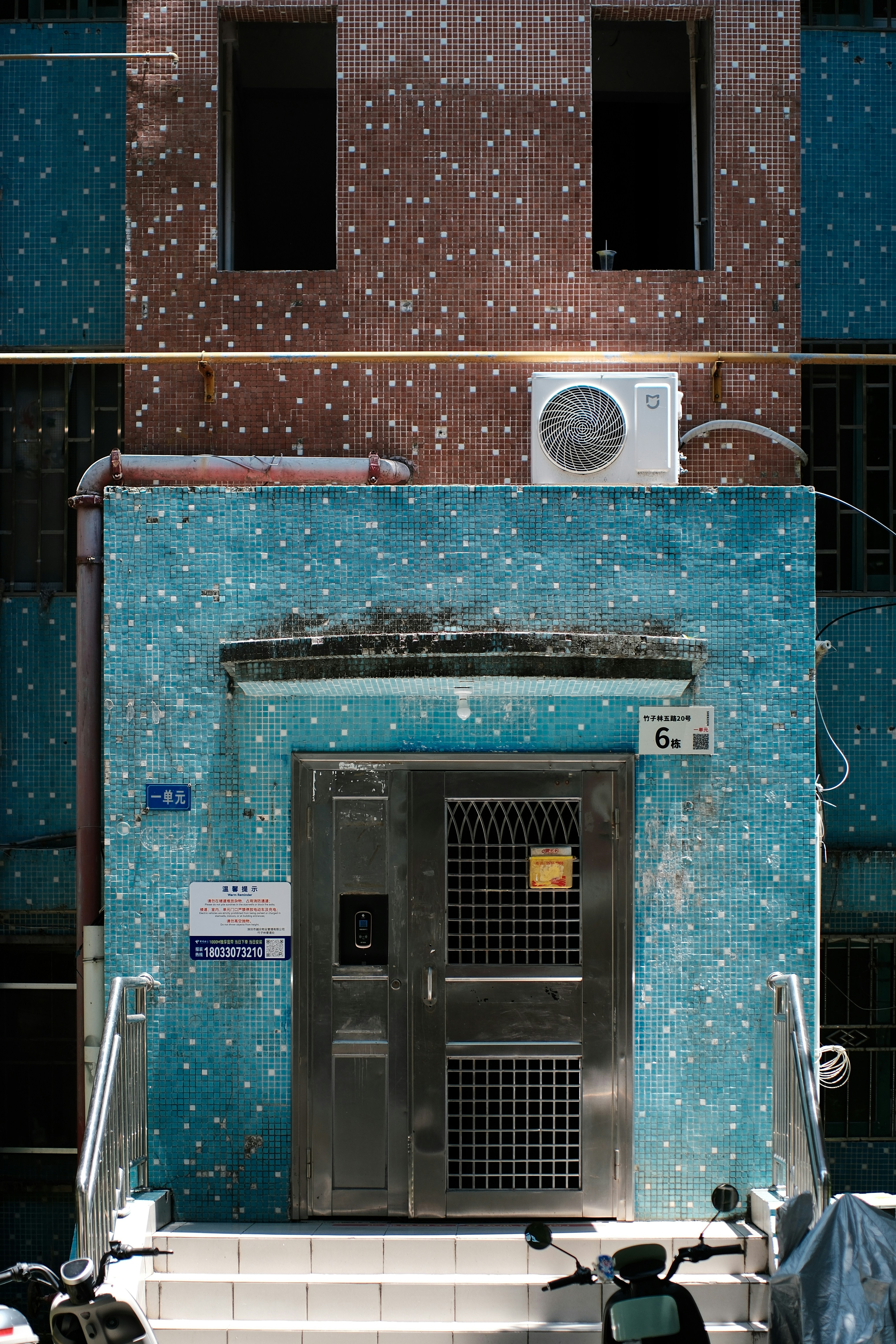 Blue Mosaic Facade and Industrial Doorway