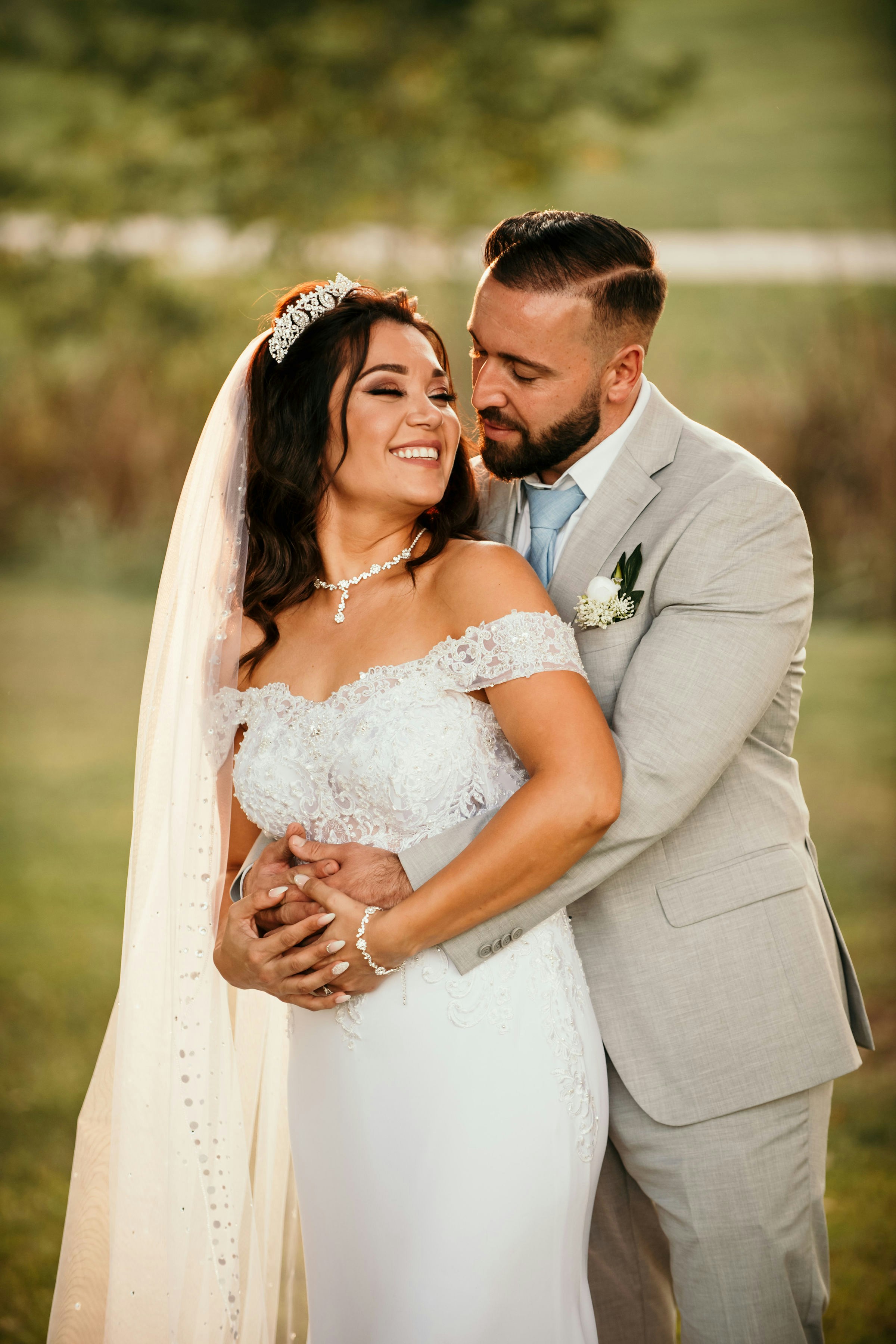 Whispered vows, radiant smiles: a tender embrace in a sunlit field
