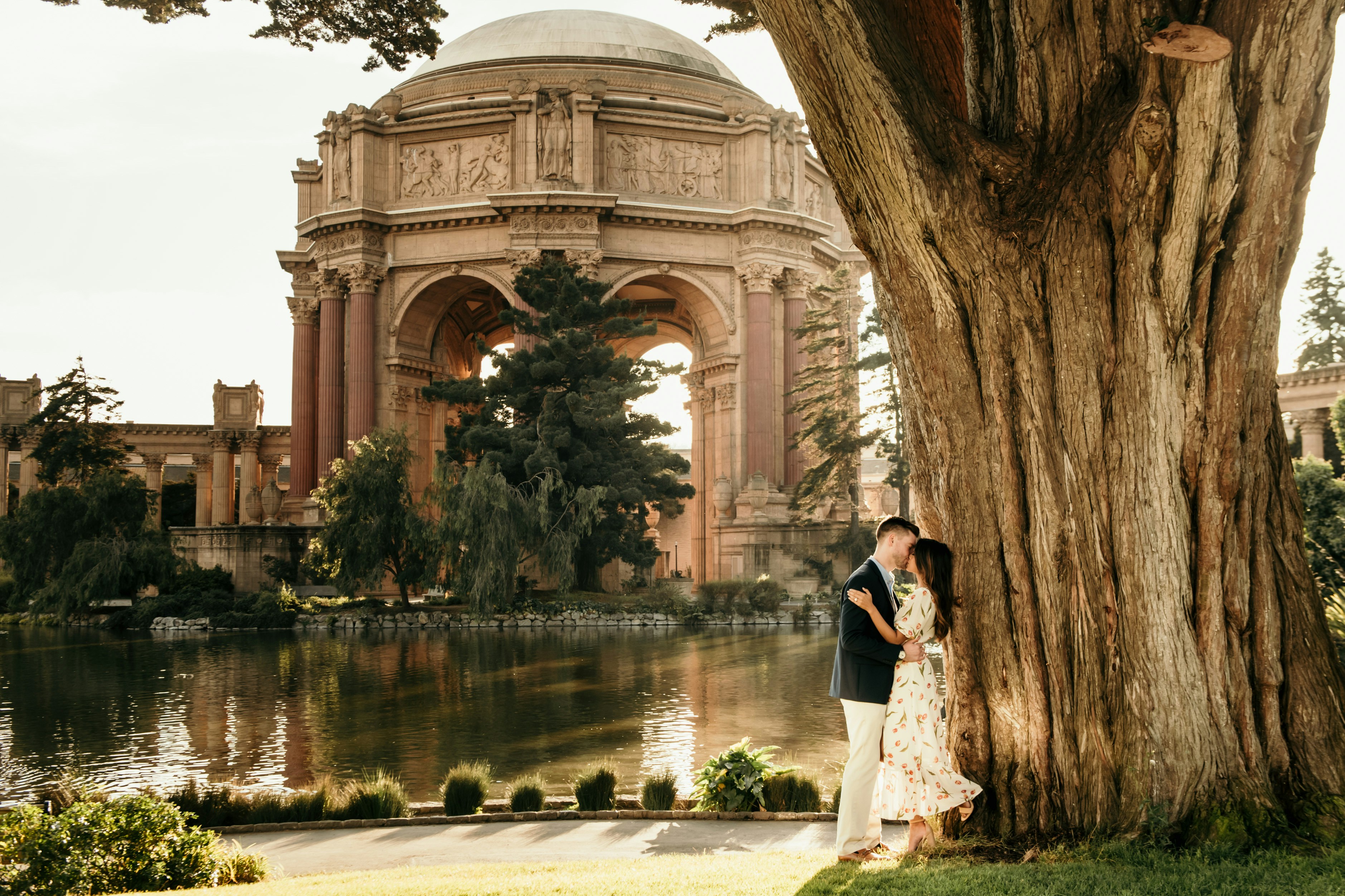 Kissing Under the Giant: A Moment by the Garden's Old Sentinel