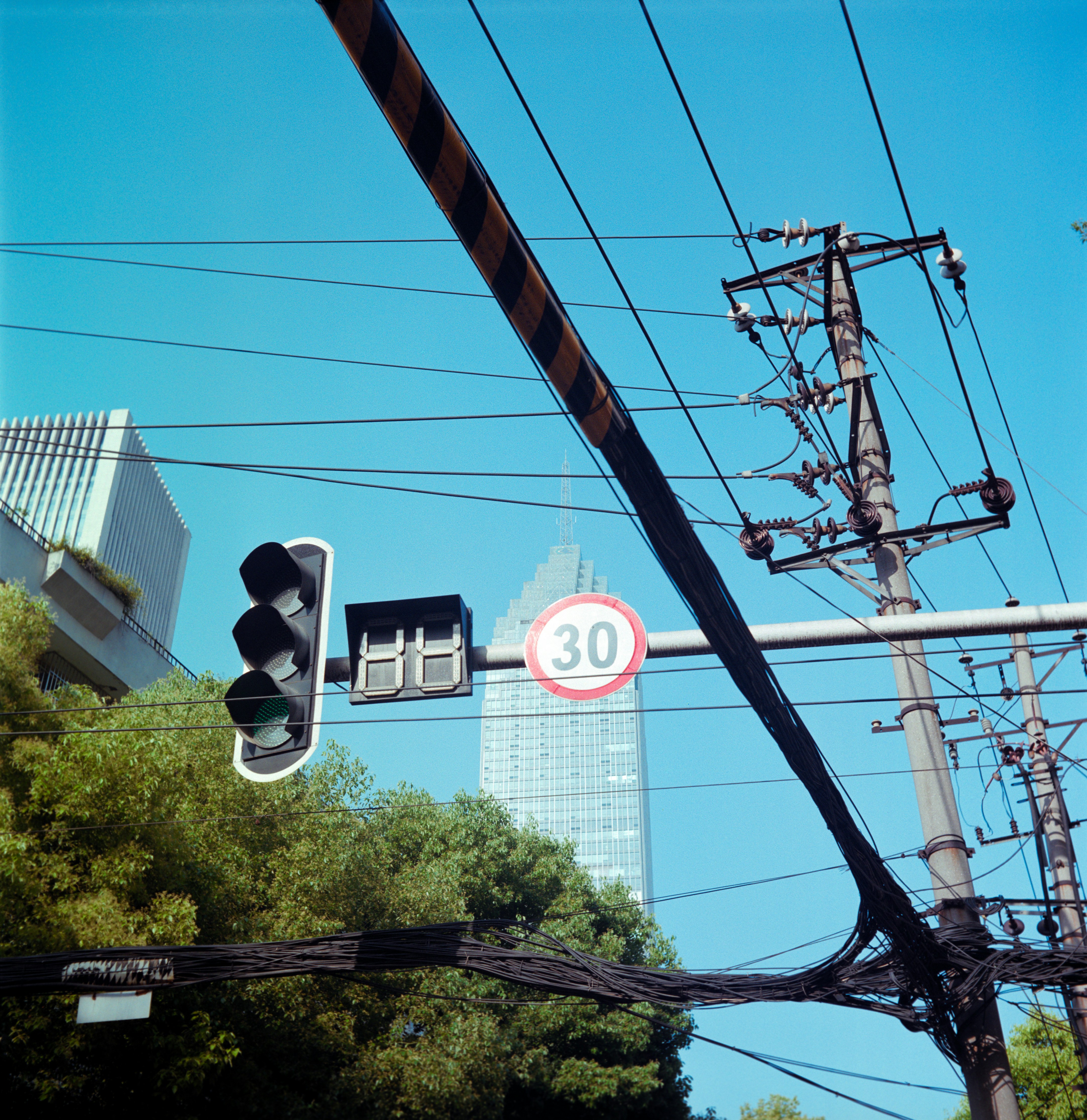 Urban Signals: A Quiet Strain of Cables Against a Blue Sky
