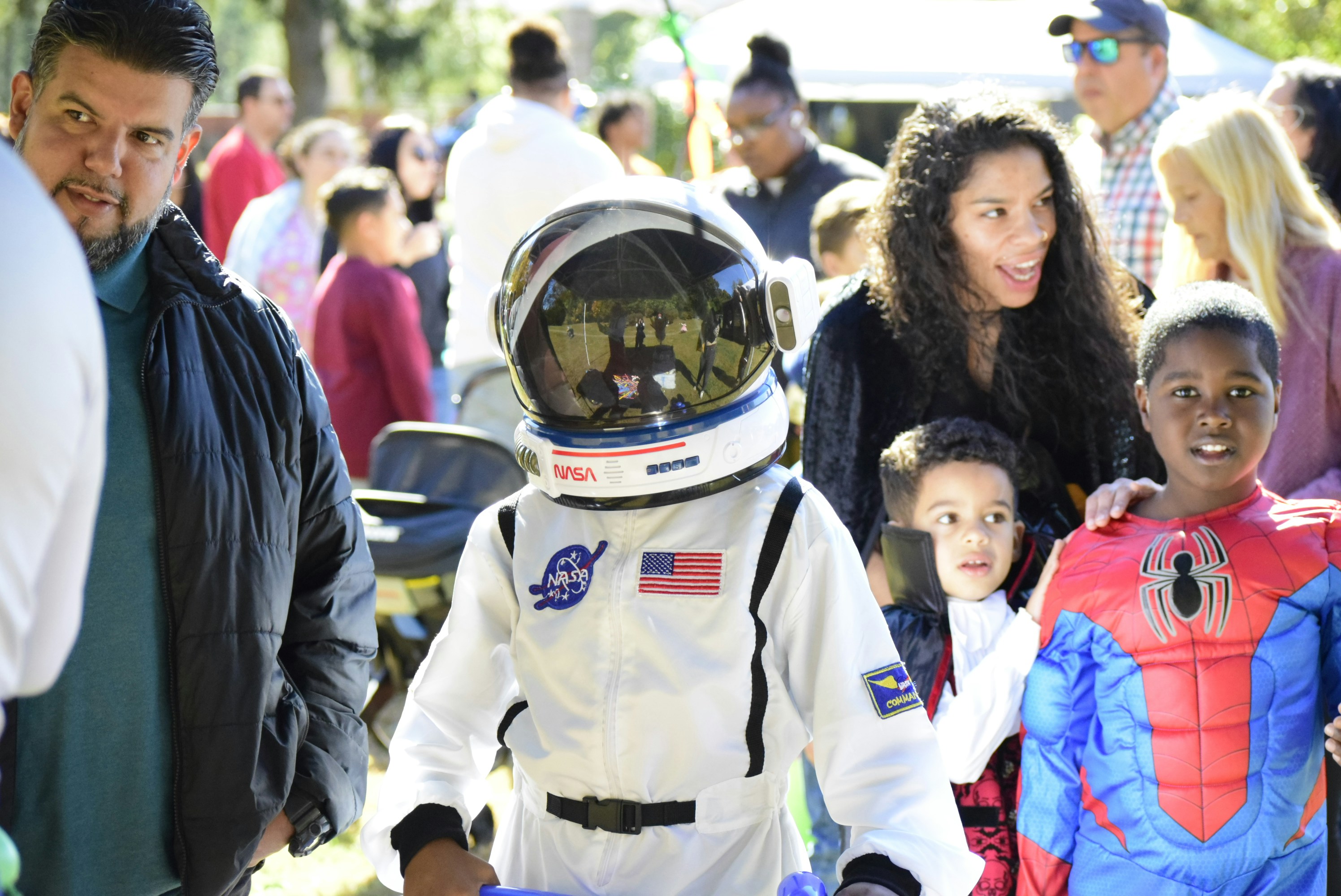 Astronaut in a crowd: a space suit stands out among family and fans