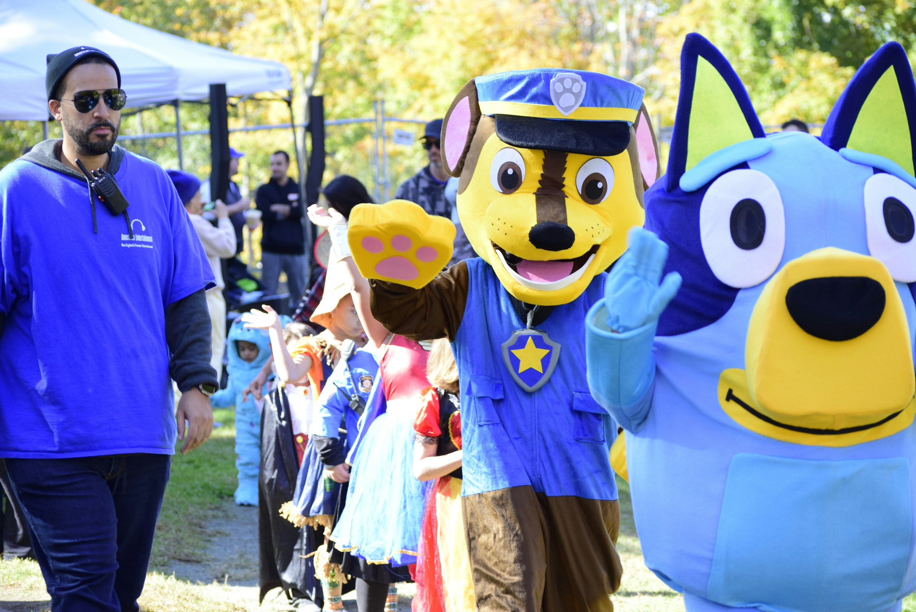 Masked Mascots Cheer at a Parkside Event