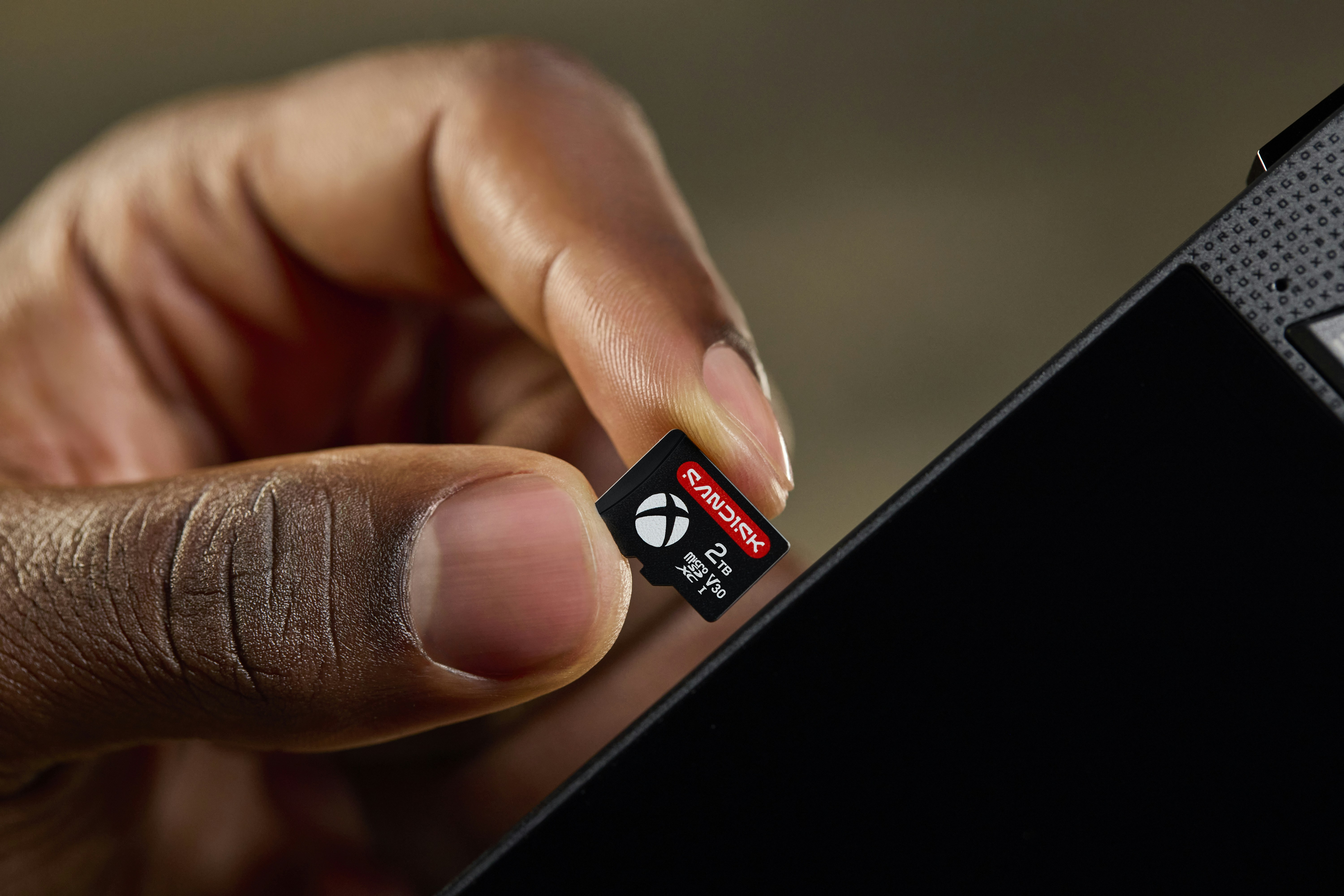 Precision in Hand: A Close-Up of a microSD Card Ready to Ingest Memory