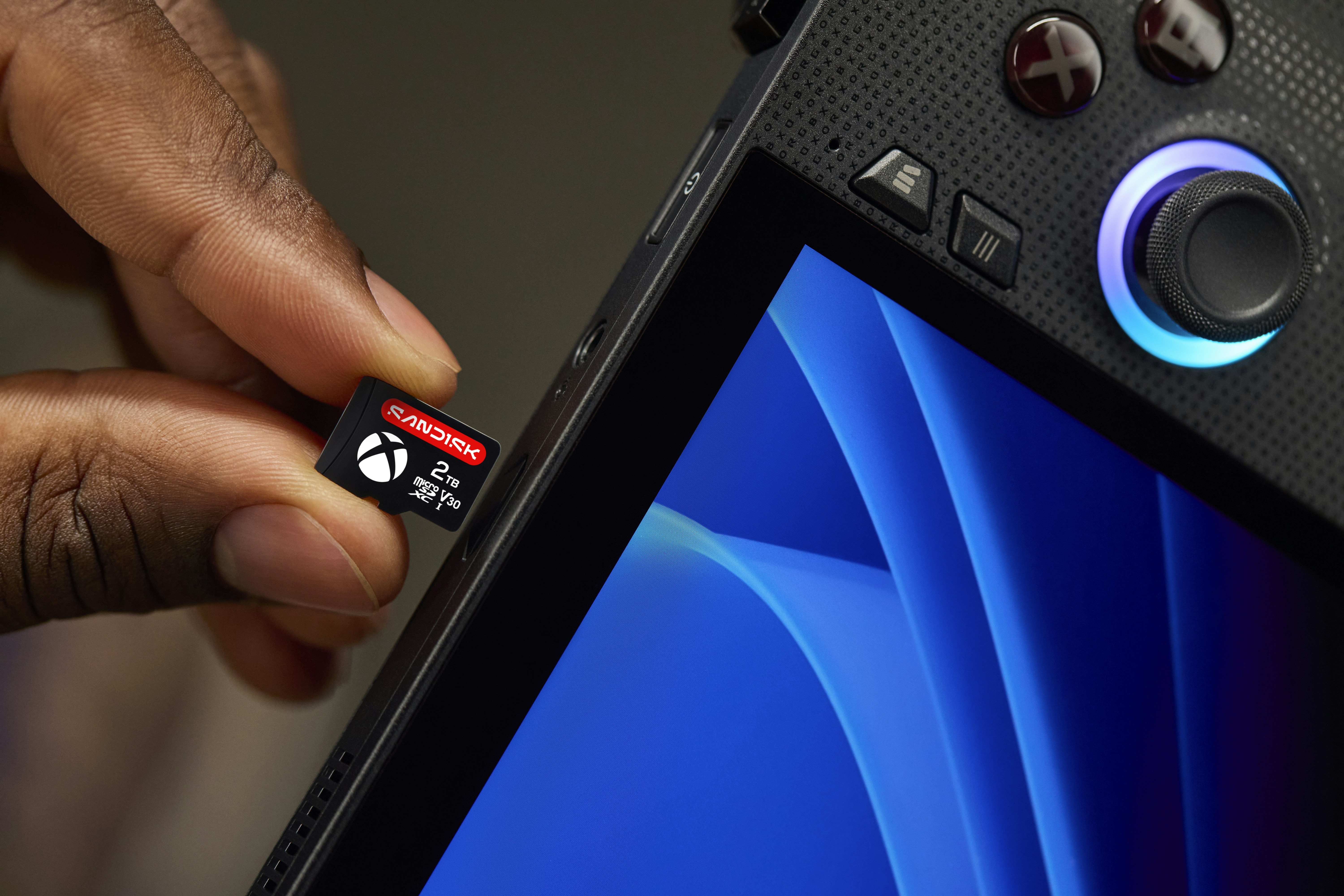 Tiny memory, bold capture: A microSD card slides into a rugged handheld gaming/photography device