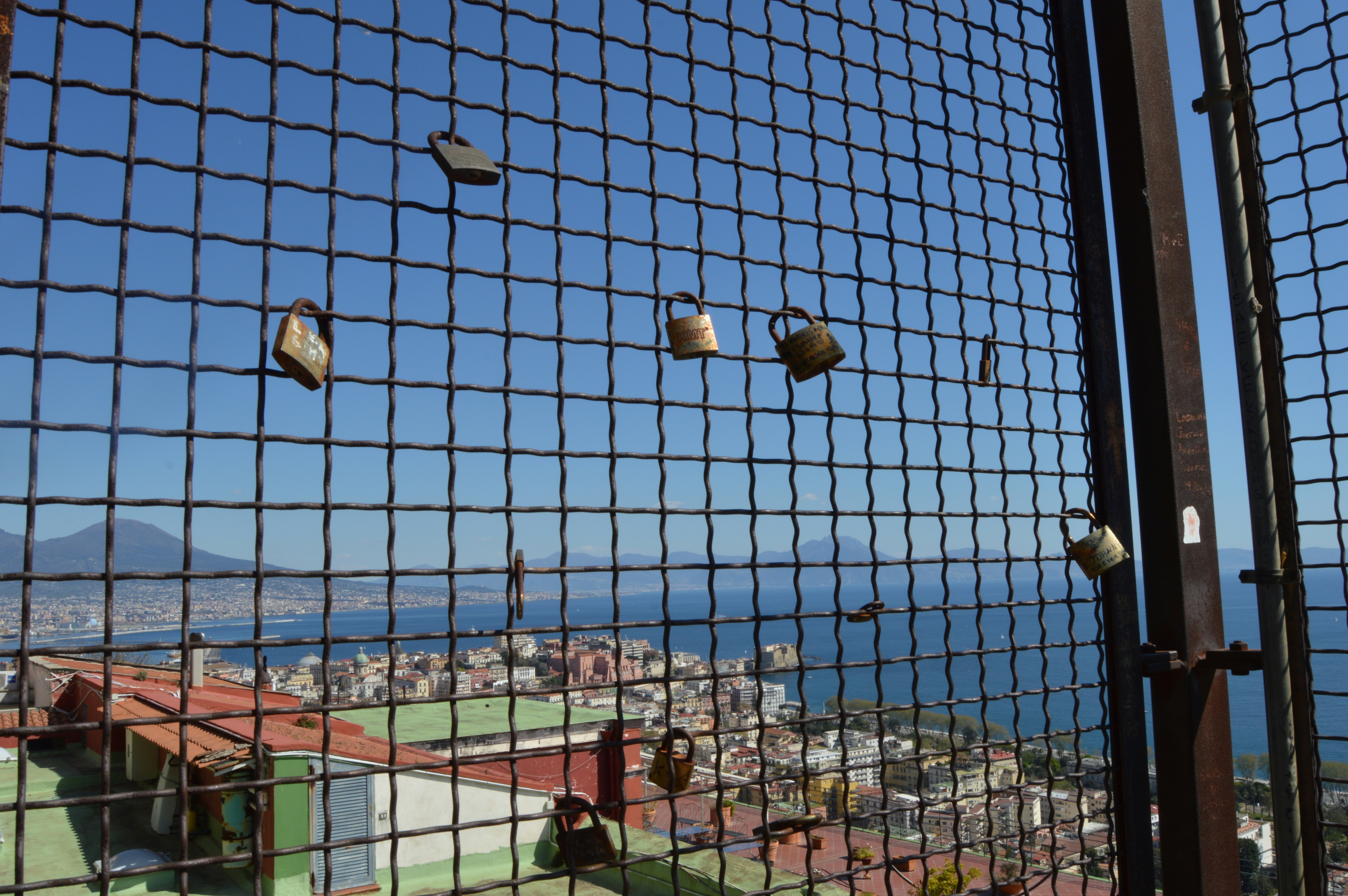 Locks on a Fence: Cityscape Beyond a Coastal Cliff