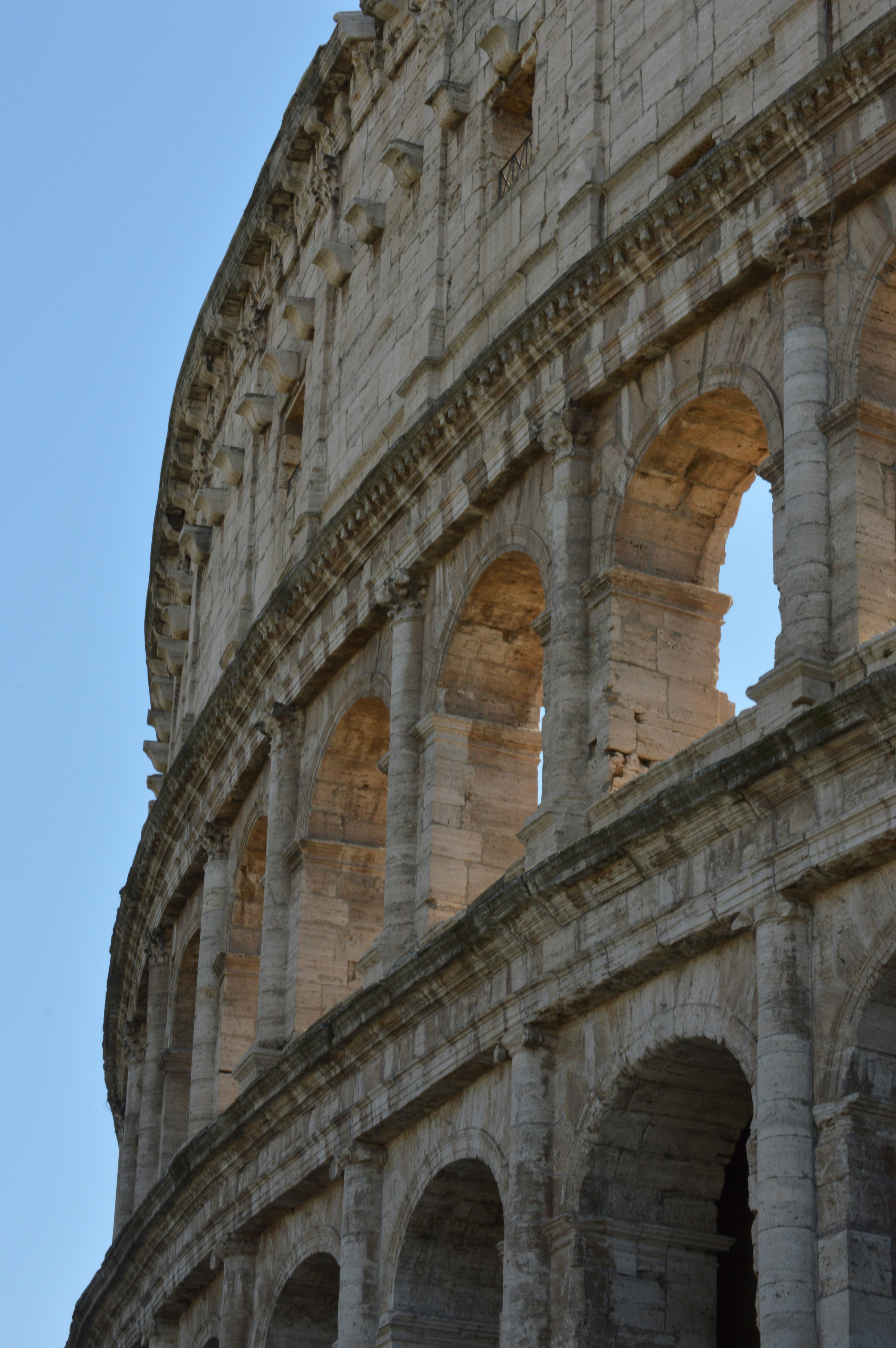 Stone Echoes of Time: Arches Against a Clear Italian Sky