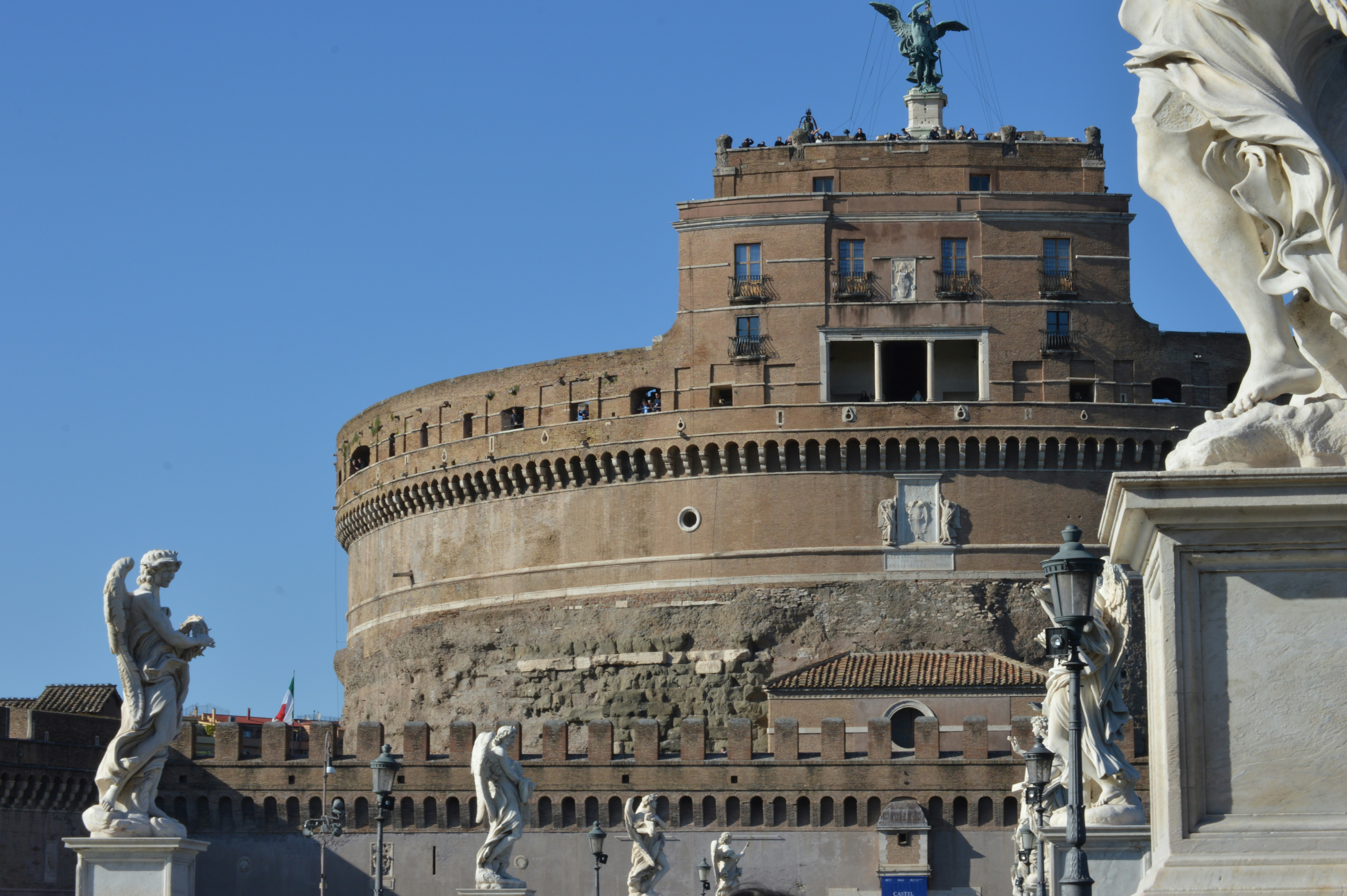 Castle and Sculpted Guardians: A Sunlit Historic Pace