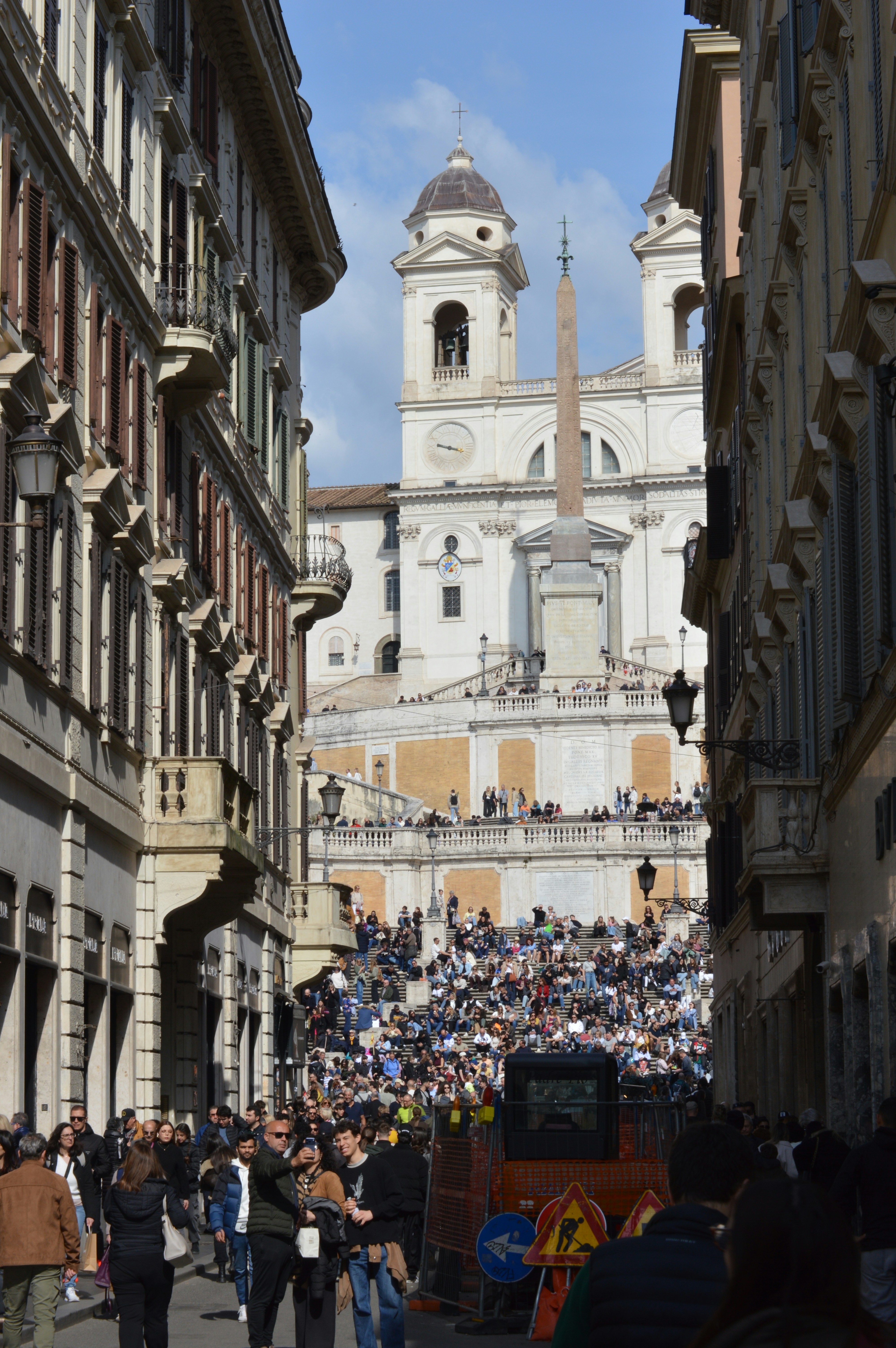 Steps to the Sacred Facade: A Crowded Street Leading to Trinità dei Monti