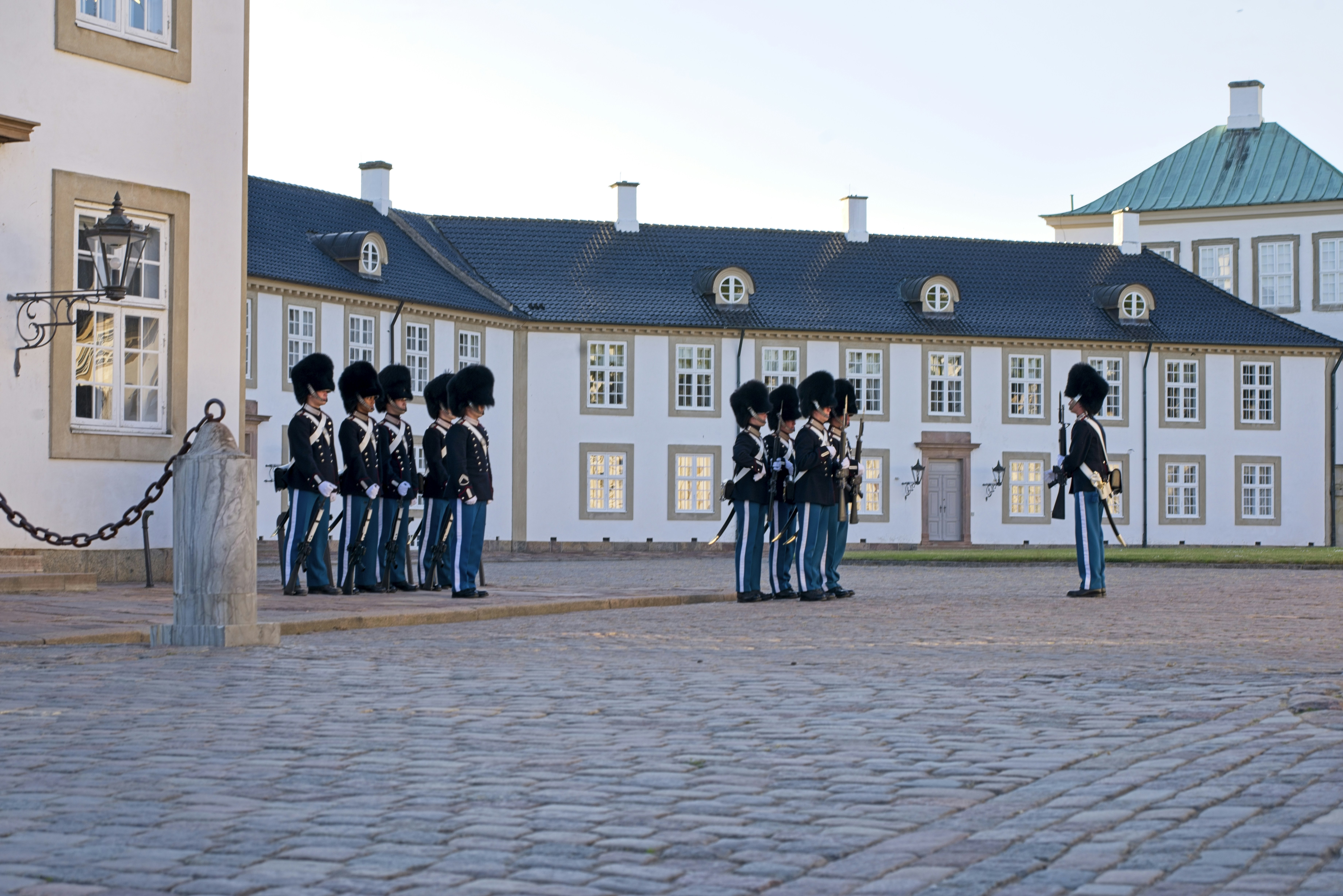 The changing of the guard at Fredensborg Palace on a sunny evening in the middle of May. The palace is located on the eastern shore of Esrum Sø in Fredensborg on the island of Sjælland in Denmark. It is the Danish royal family’s spring and autumn residence and is often the site of important state visits and royal family events. It is the most frequently used of the royal family’s residences.