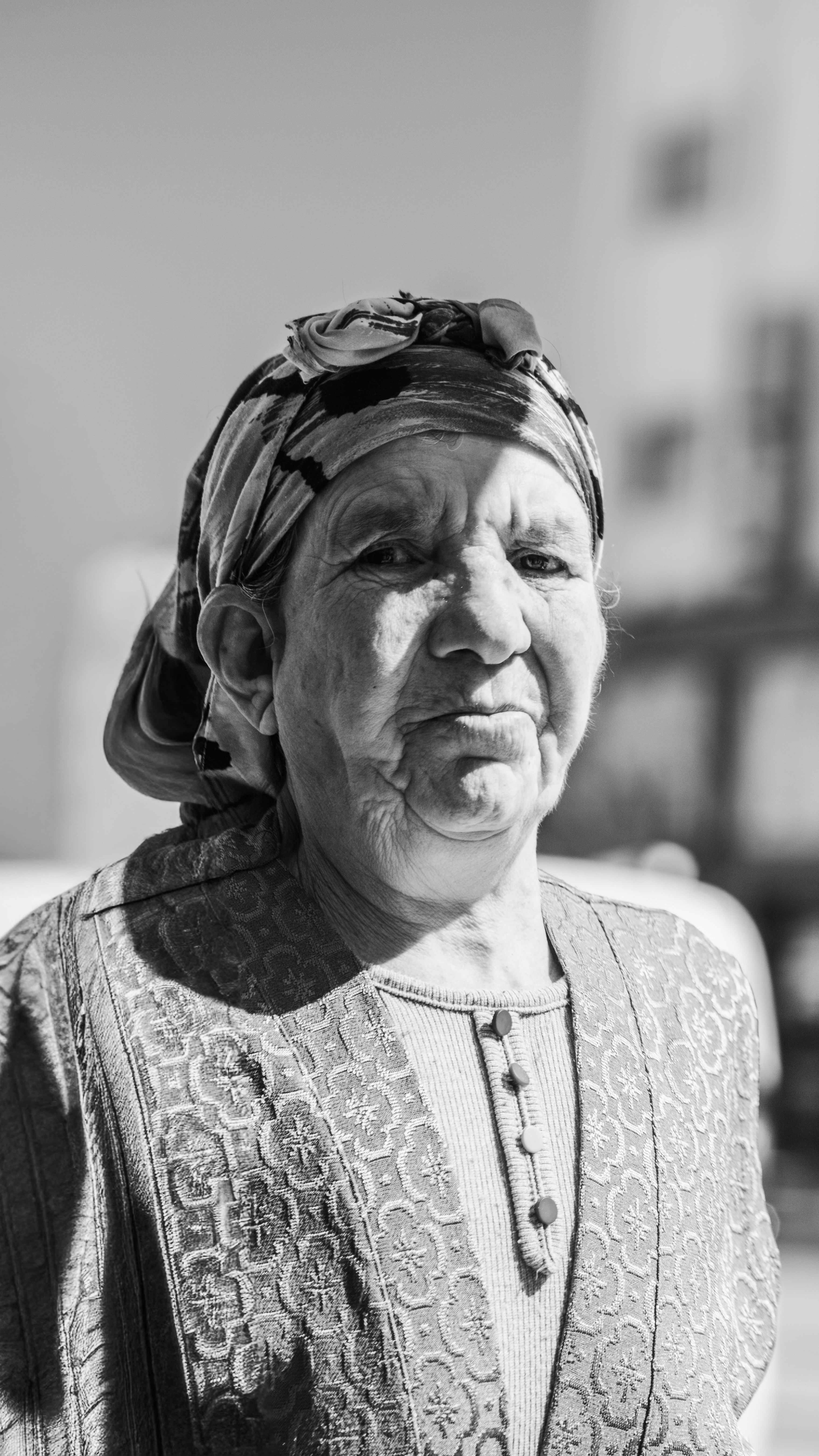 Portrait of Weathered Wisdom: A Headscarf and Lines That Tell a Life
