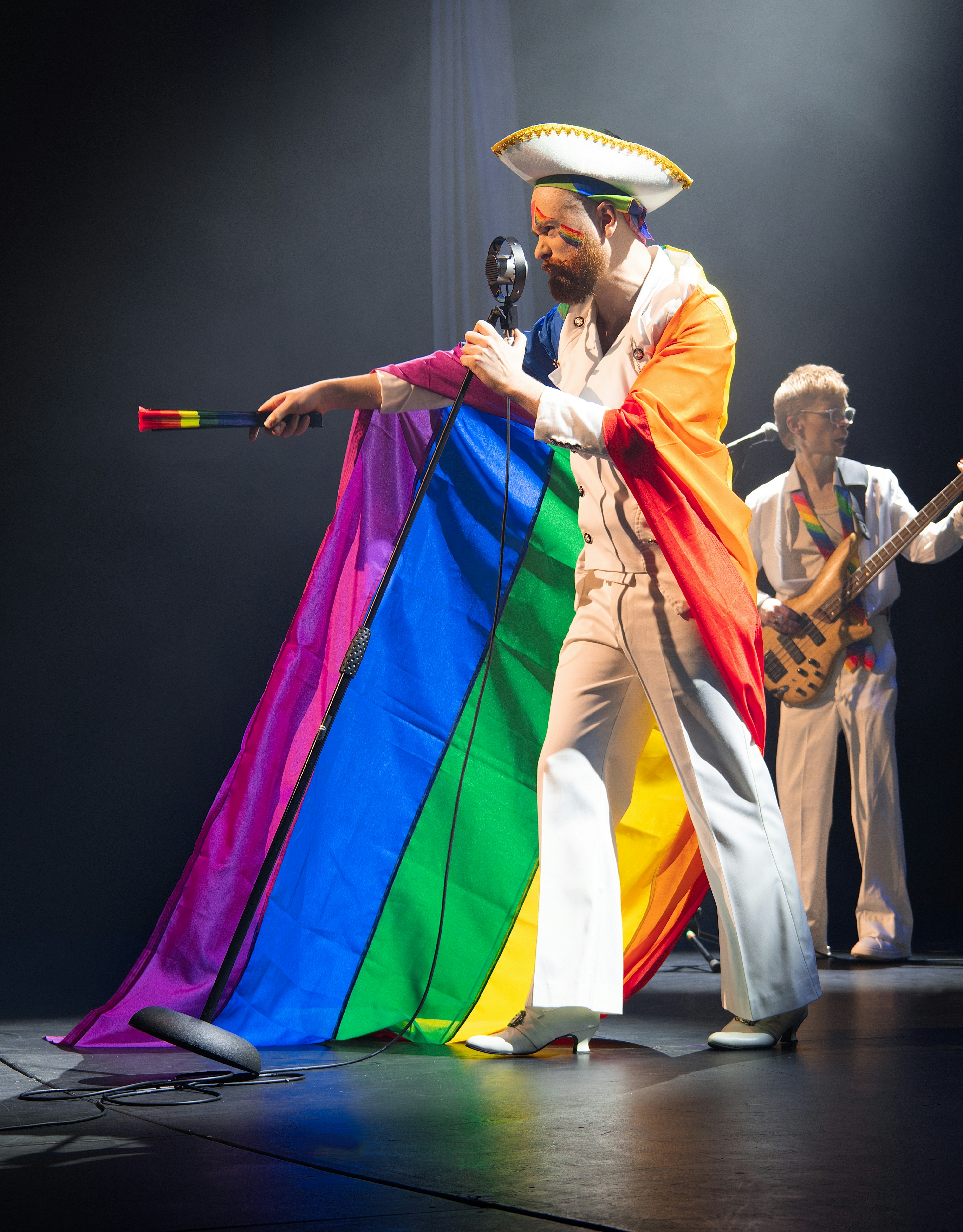 Rainbow Cape Serenade: A Showman Under Spotlight