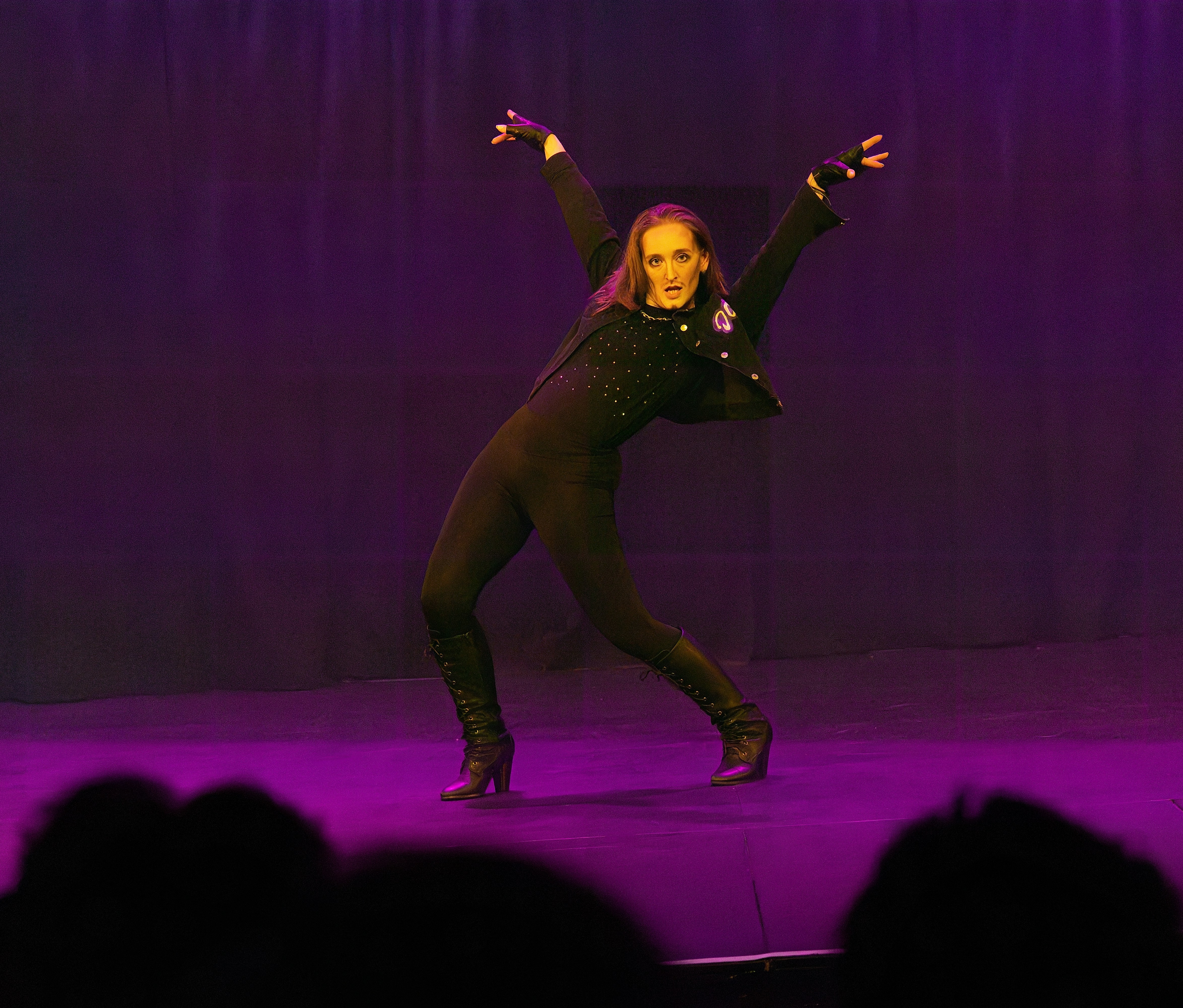 Mid-Stage Ferocity: A Dancer Blooms in Purple Spotlight