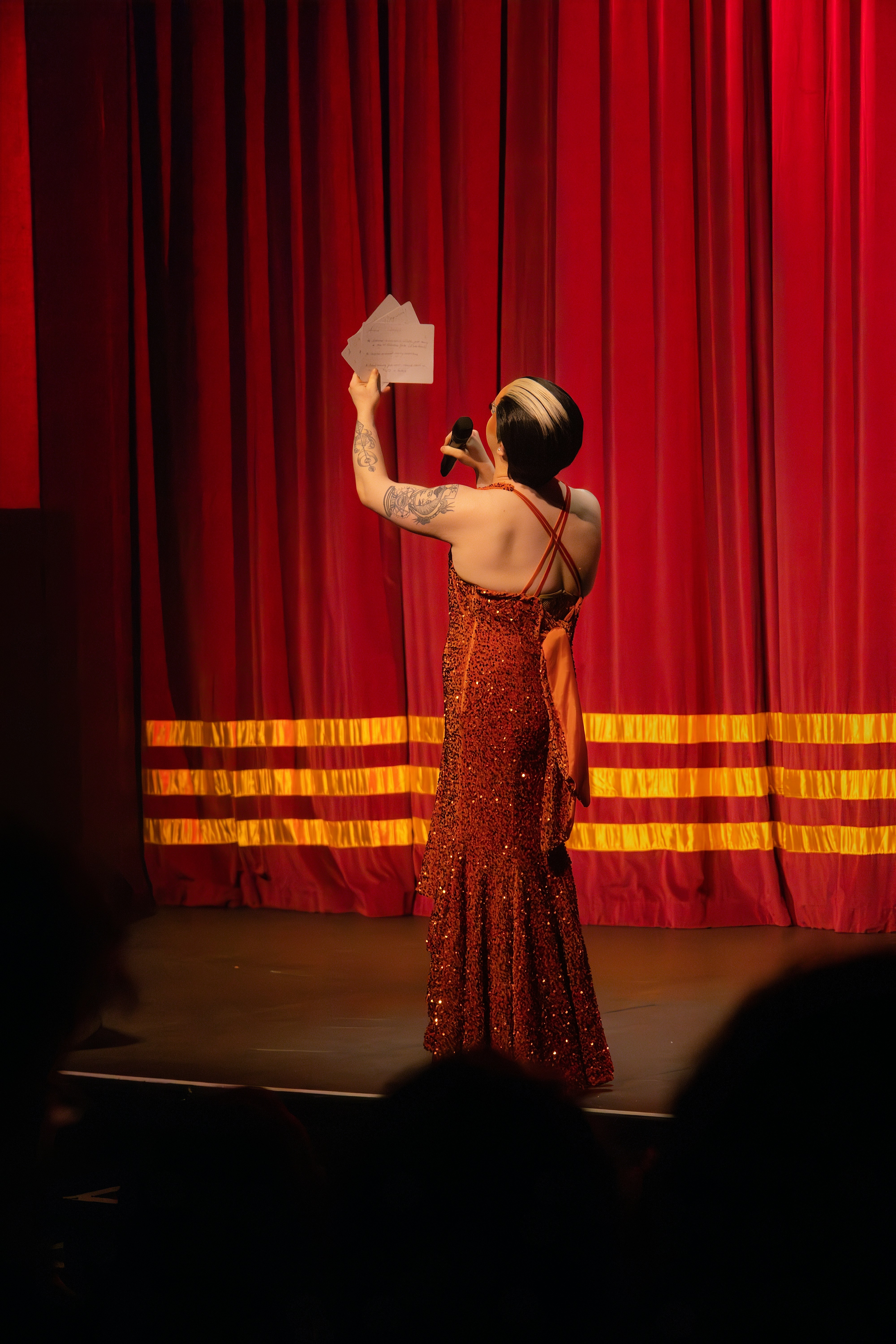 Spotlight On Stage: A Solo Singer in a Sparkling Red Gown