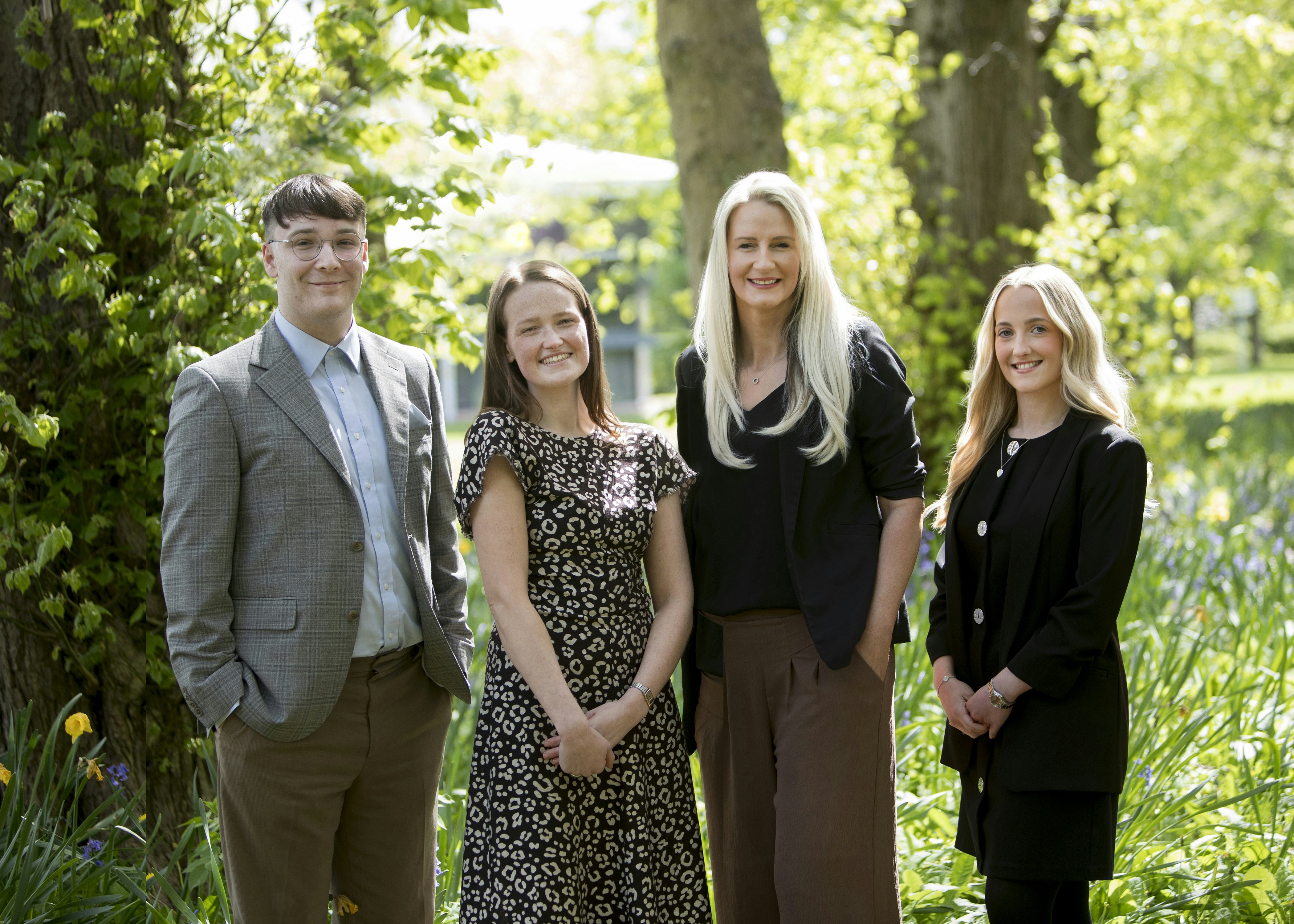 A Portrait of Four Colleagues in a Sunlit Park