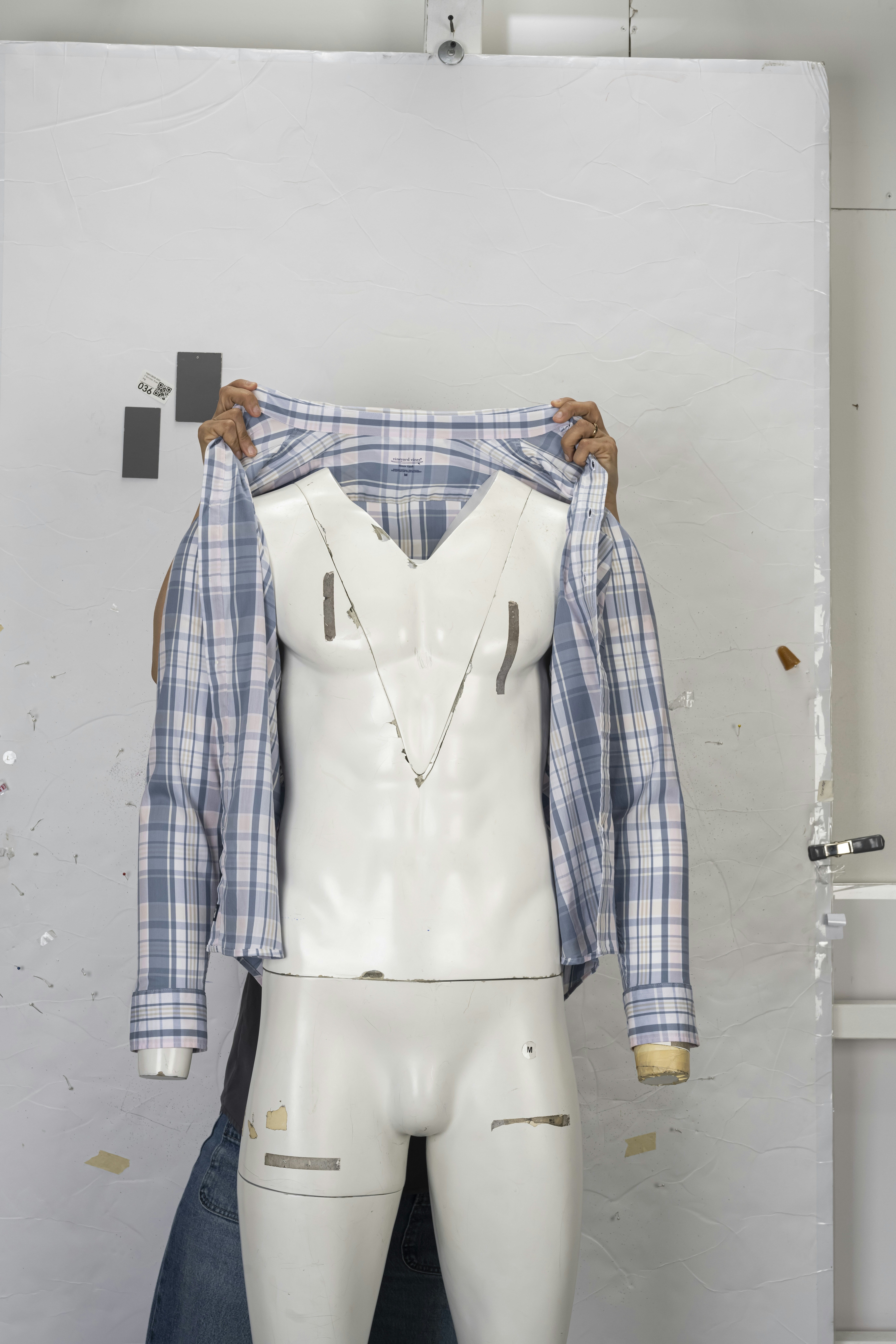 Second Skin: A Headless Mannequin Wearing a Light Plaid Shirt over a White Bodice