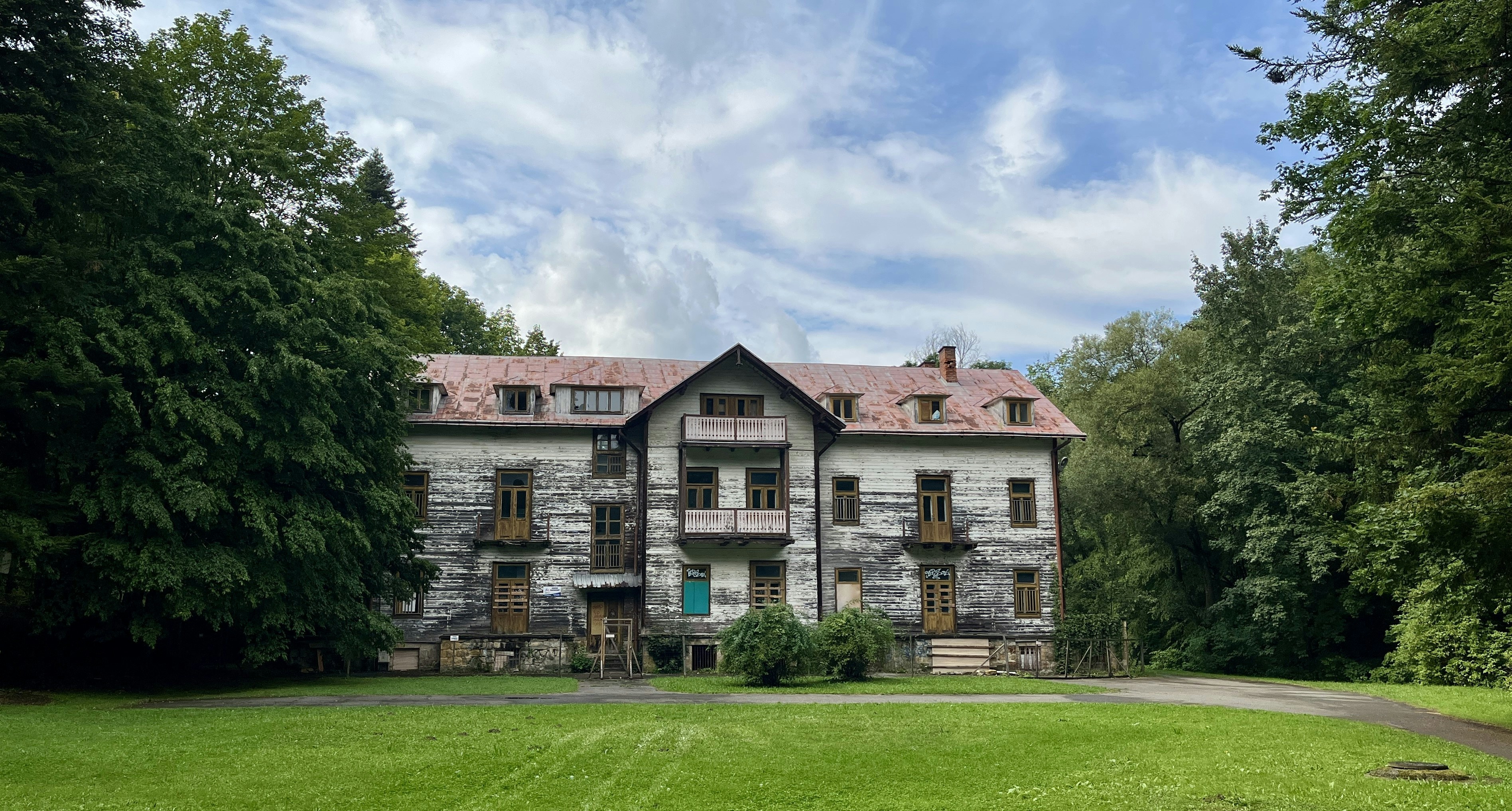 Ruined Manor Framed by Verdant Clearing