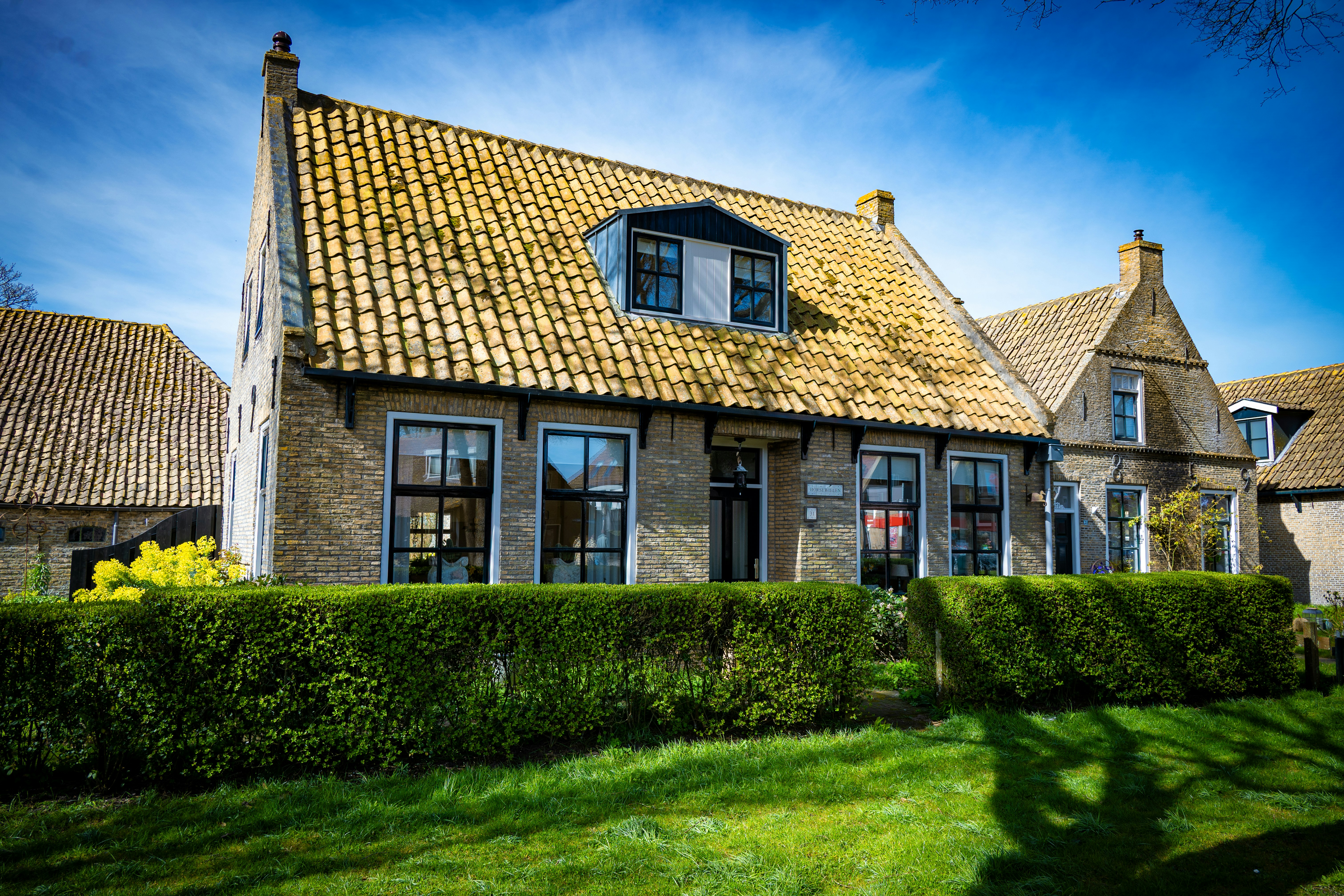 Thatched Cottage Facade Under Bright Summer Sky