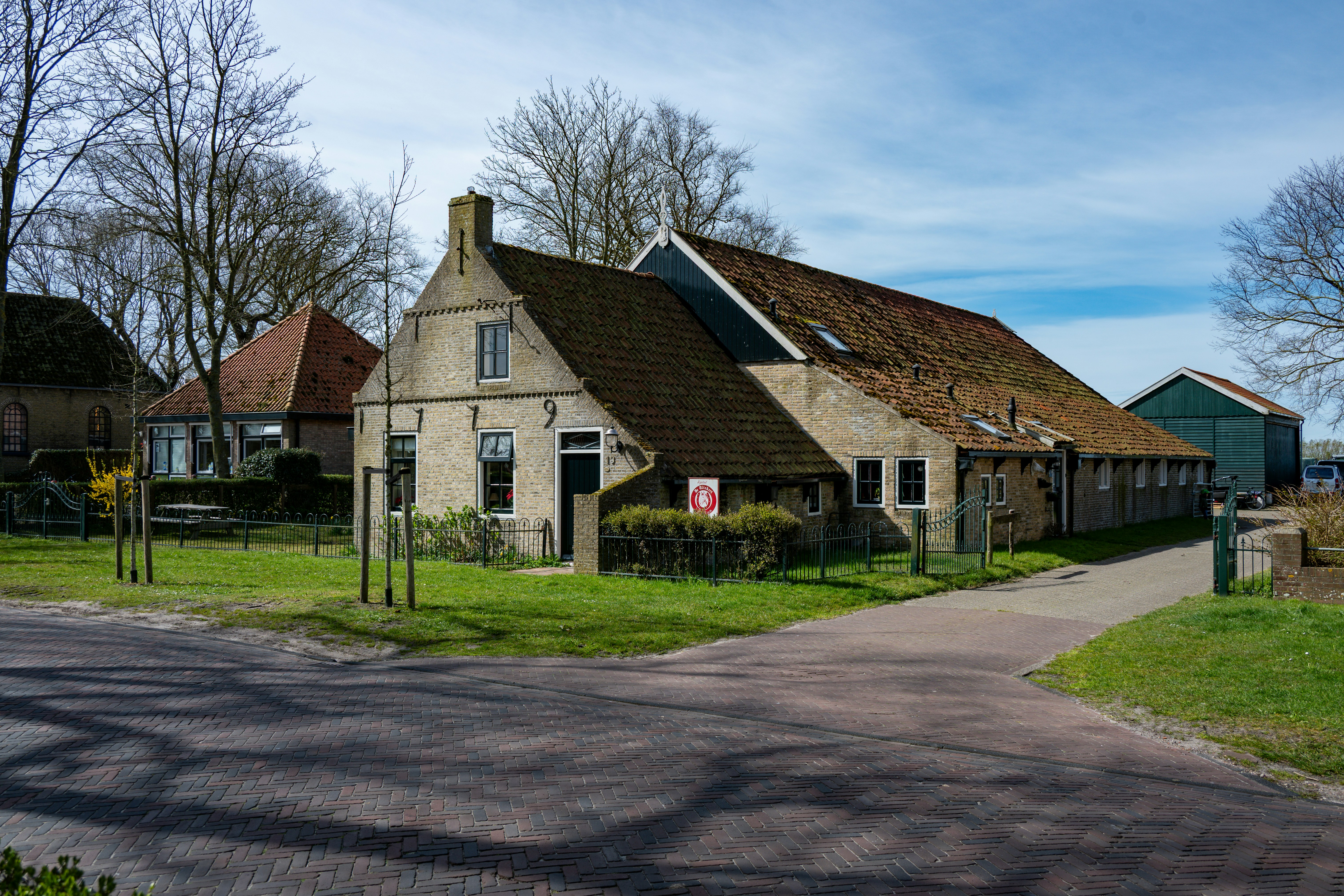 Quaint Delft-style Row: Sunlit Village Facades and Winding Path