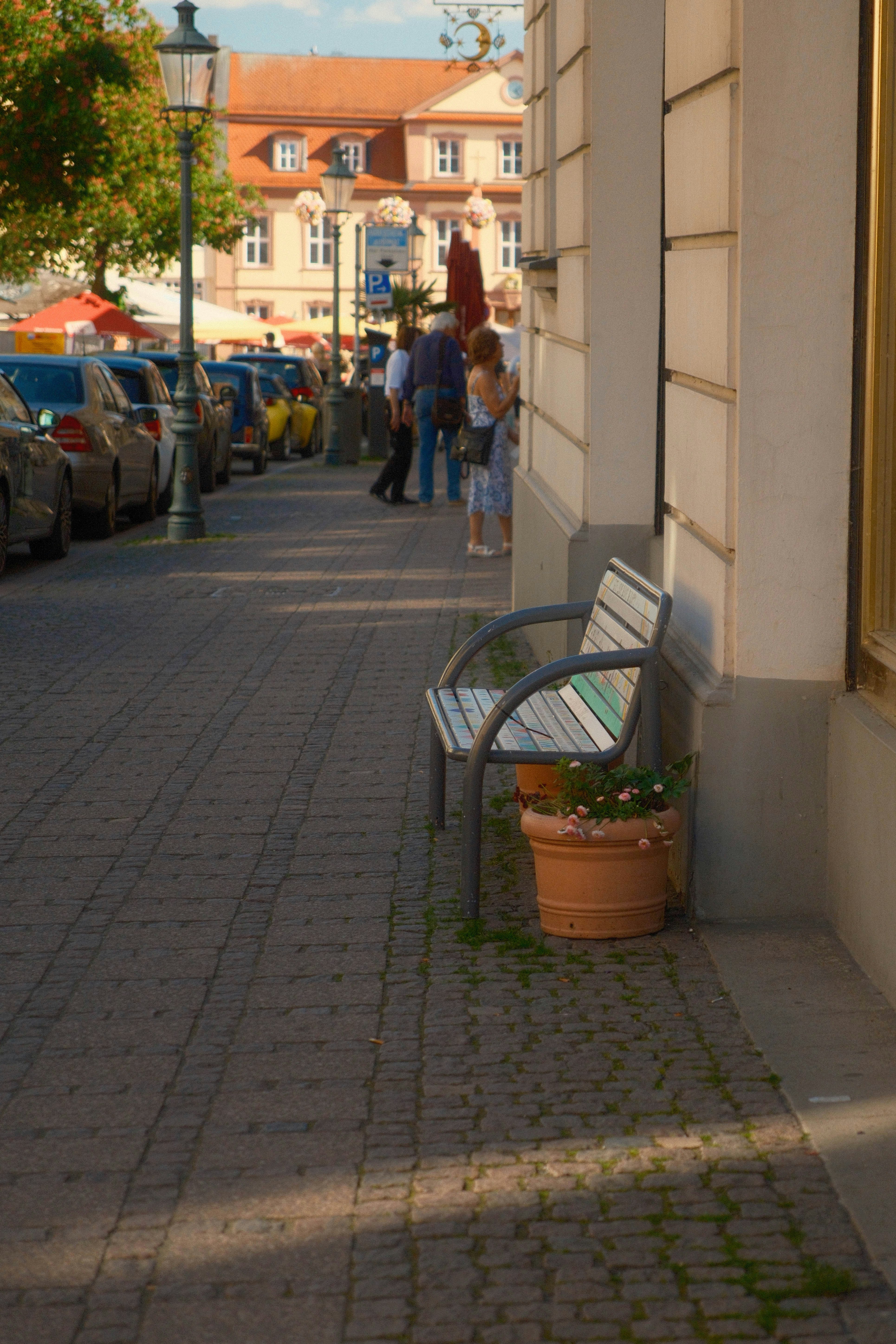 Sunlit Street Bench: Quiet Corner by a European Facade