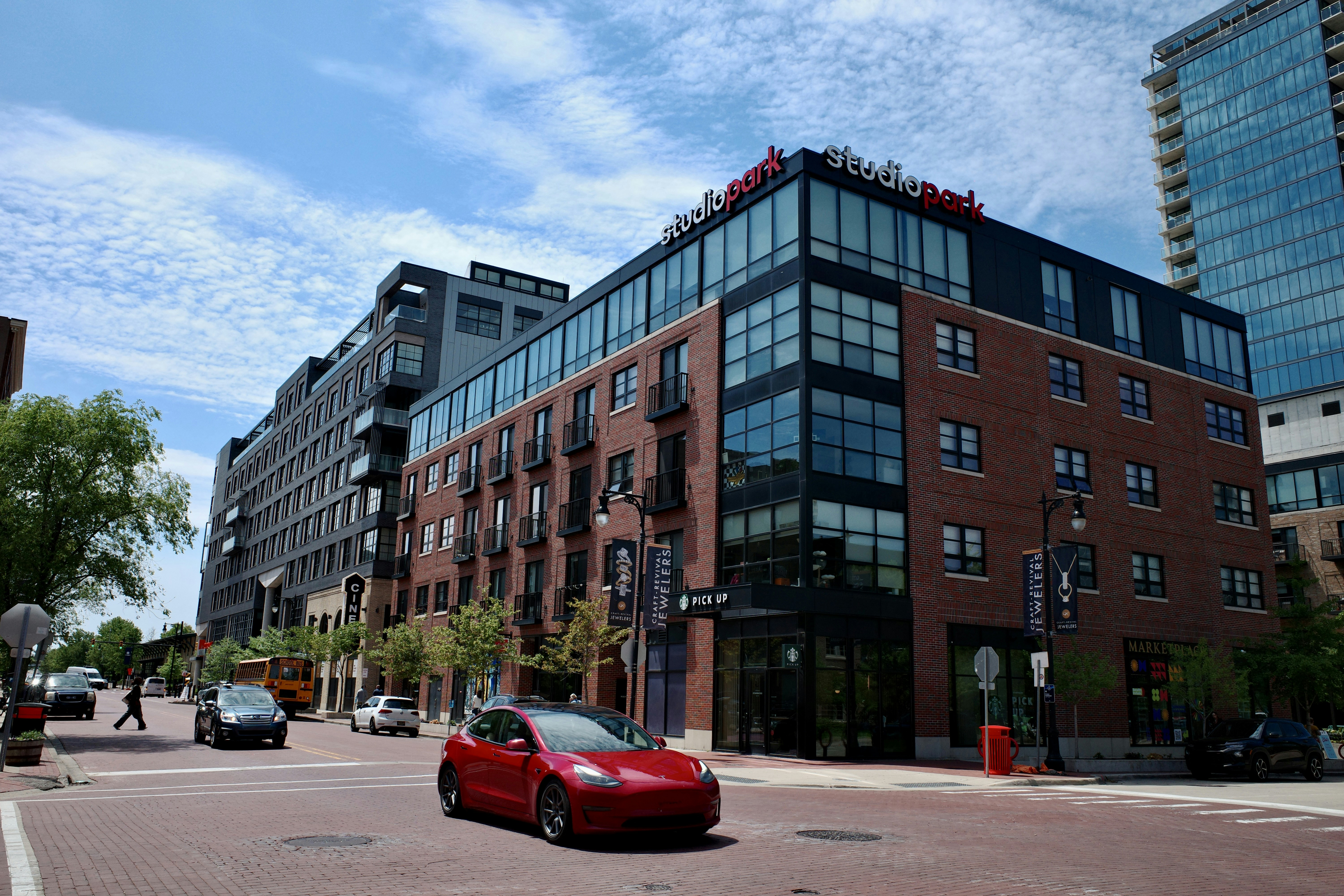 Red Tesla at the Corner of Modern Brick and Glass