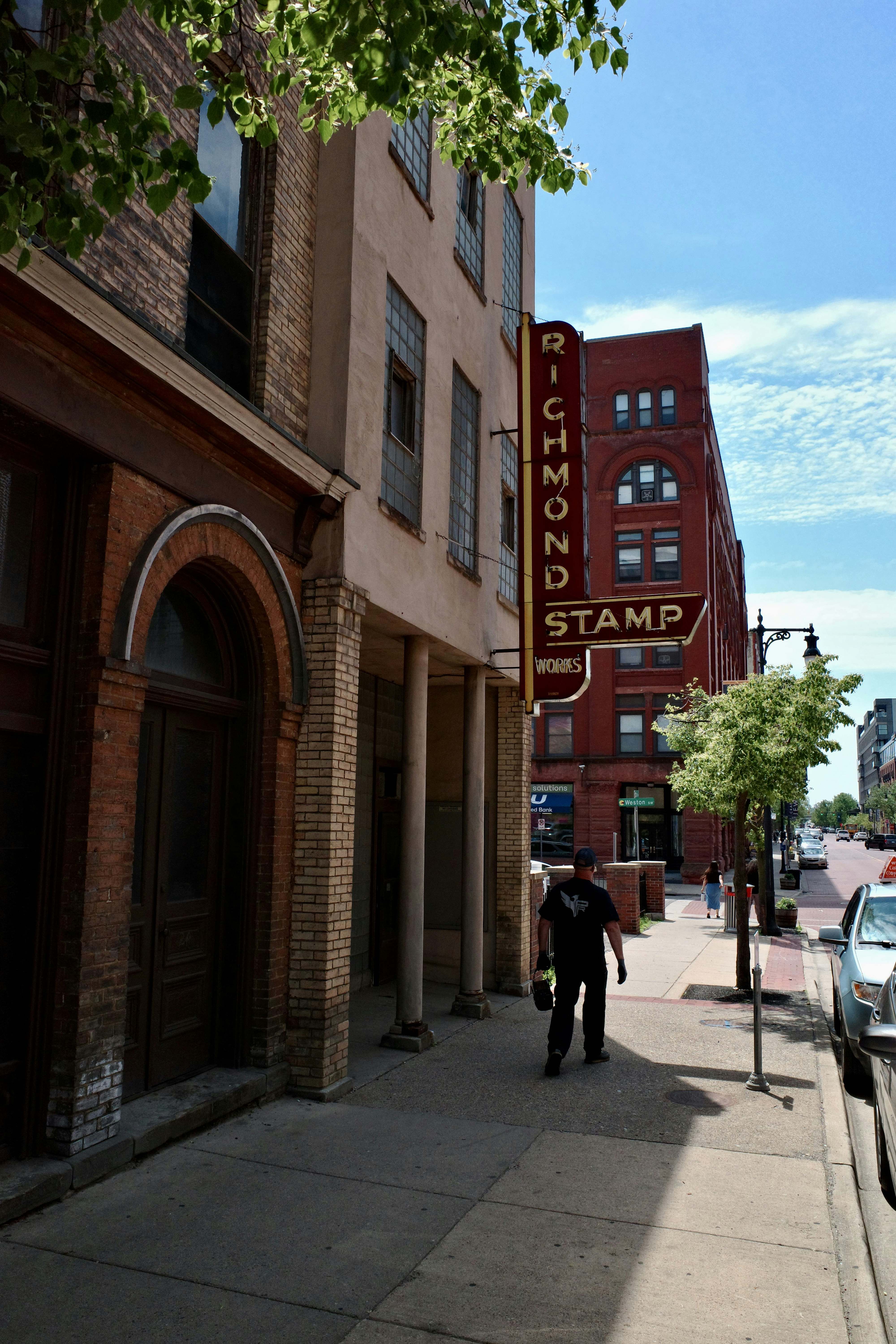 Red Brick Street, Neon Sign, and Shadowed Figure