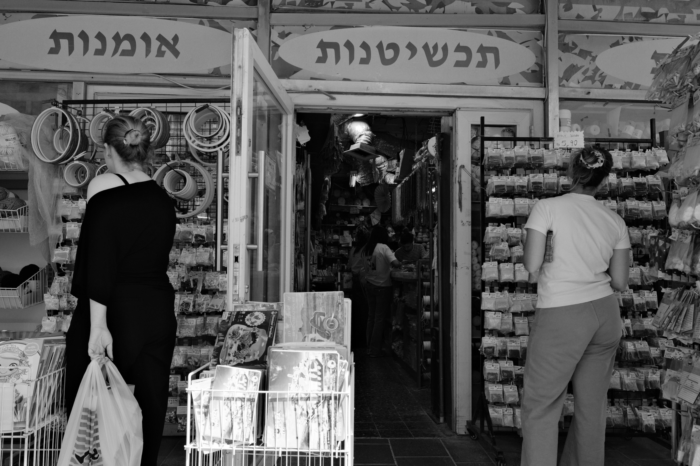 Cartilage and Commerce: A grayscale stroll through a bustling market doorway