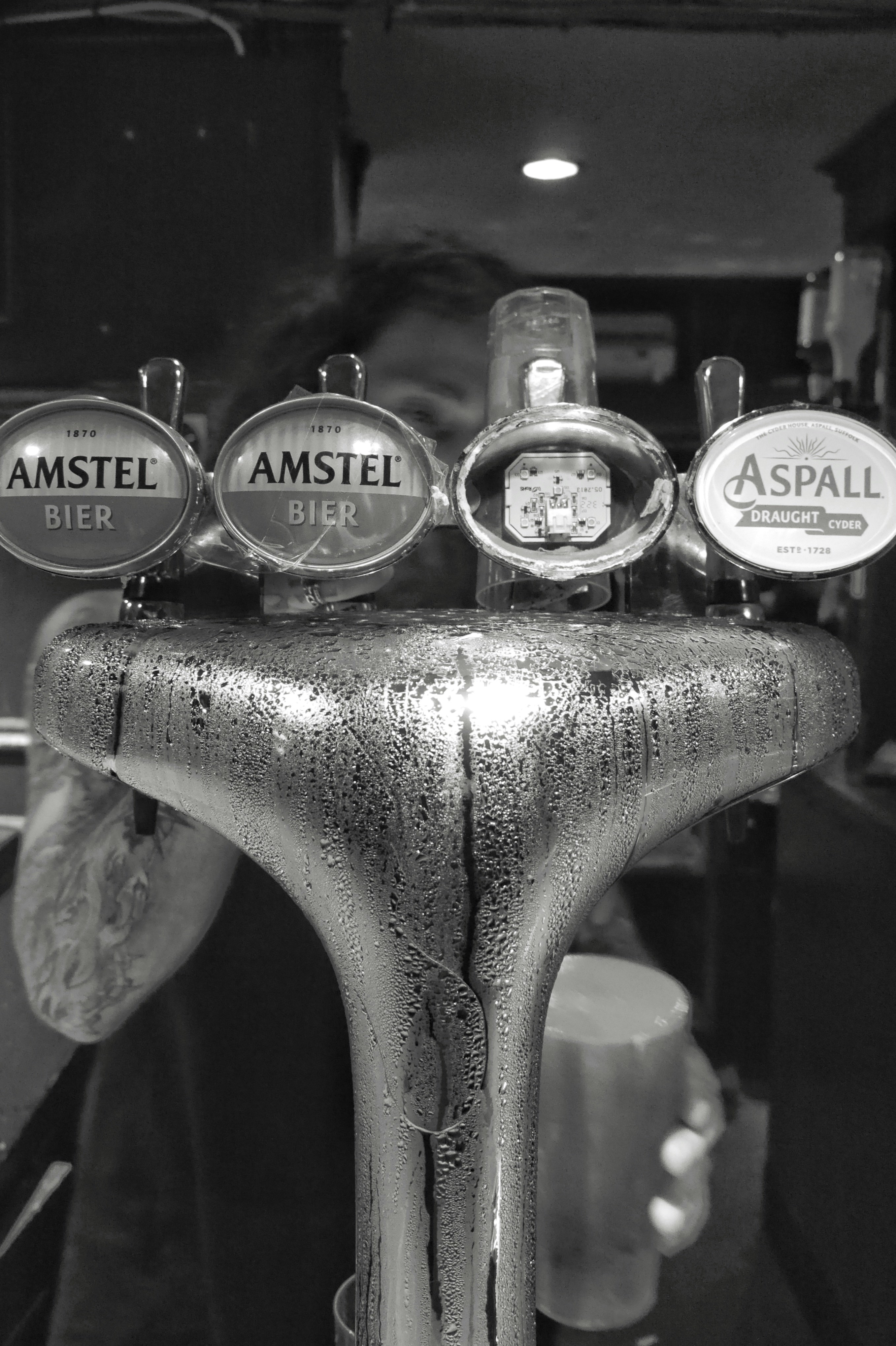 Cocked taps and glistening chrome: a bar scene in monochrome