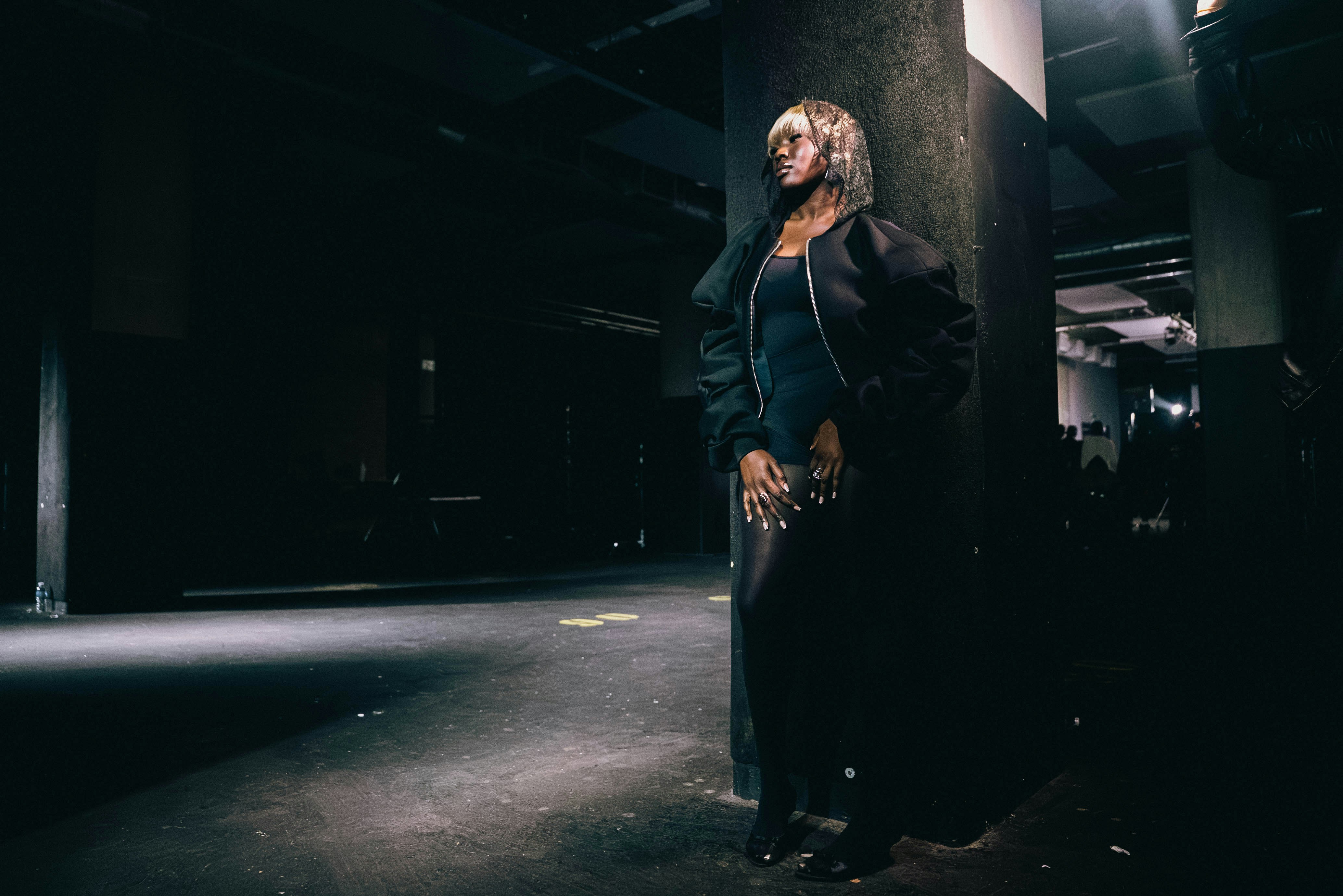 Midnight Spotlight: A Confident Figure by the Pillar