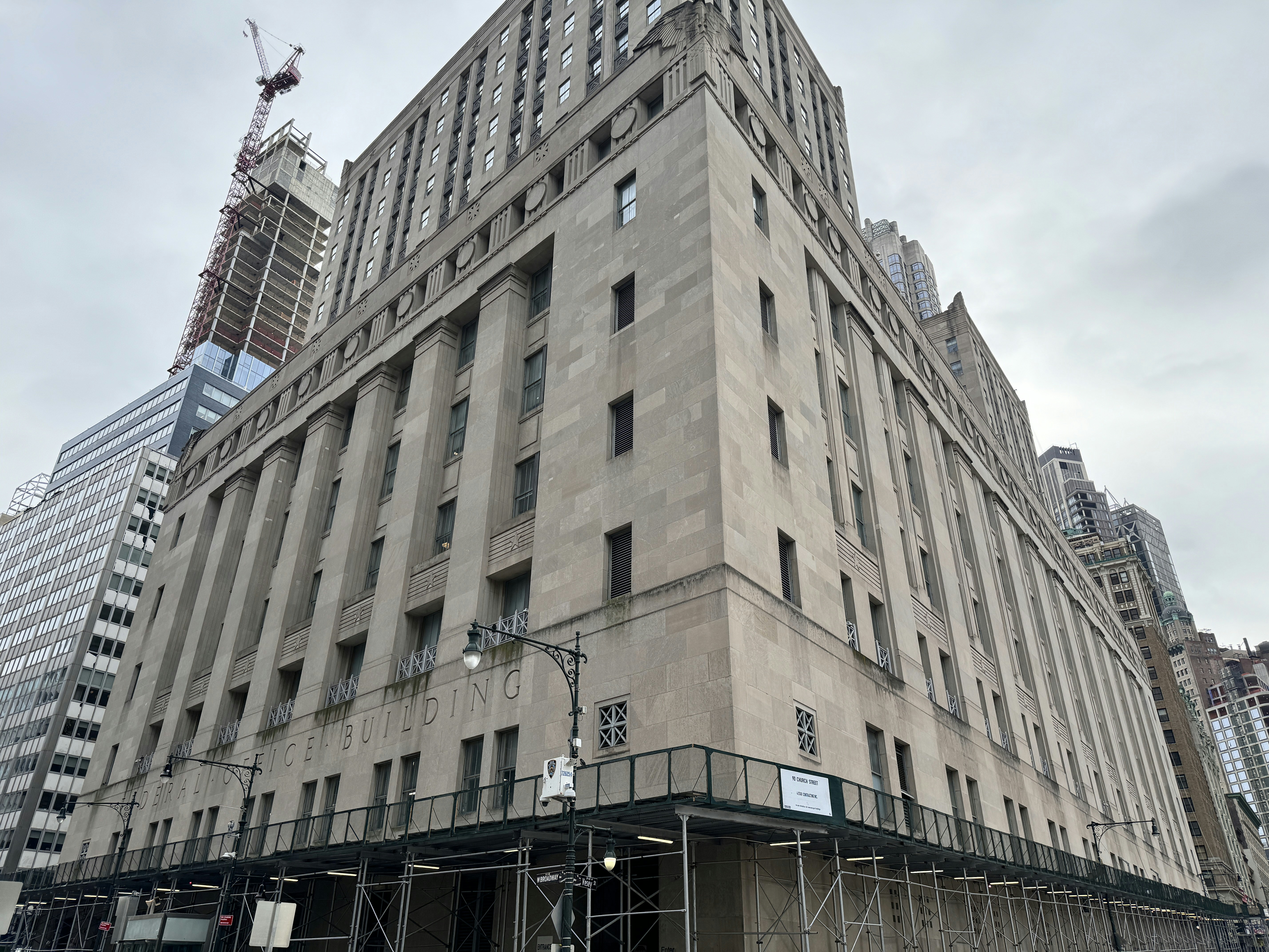 Cornered by Concrete: A Historic Facade Rising Over Street-Level Scaffolding