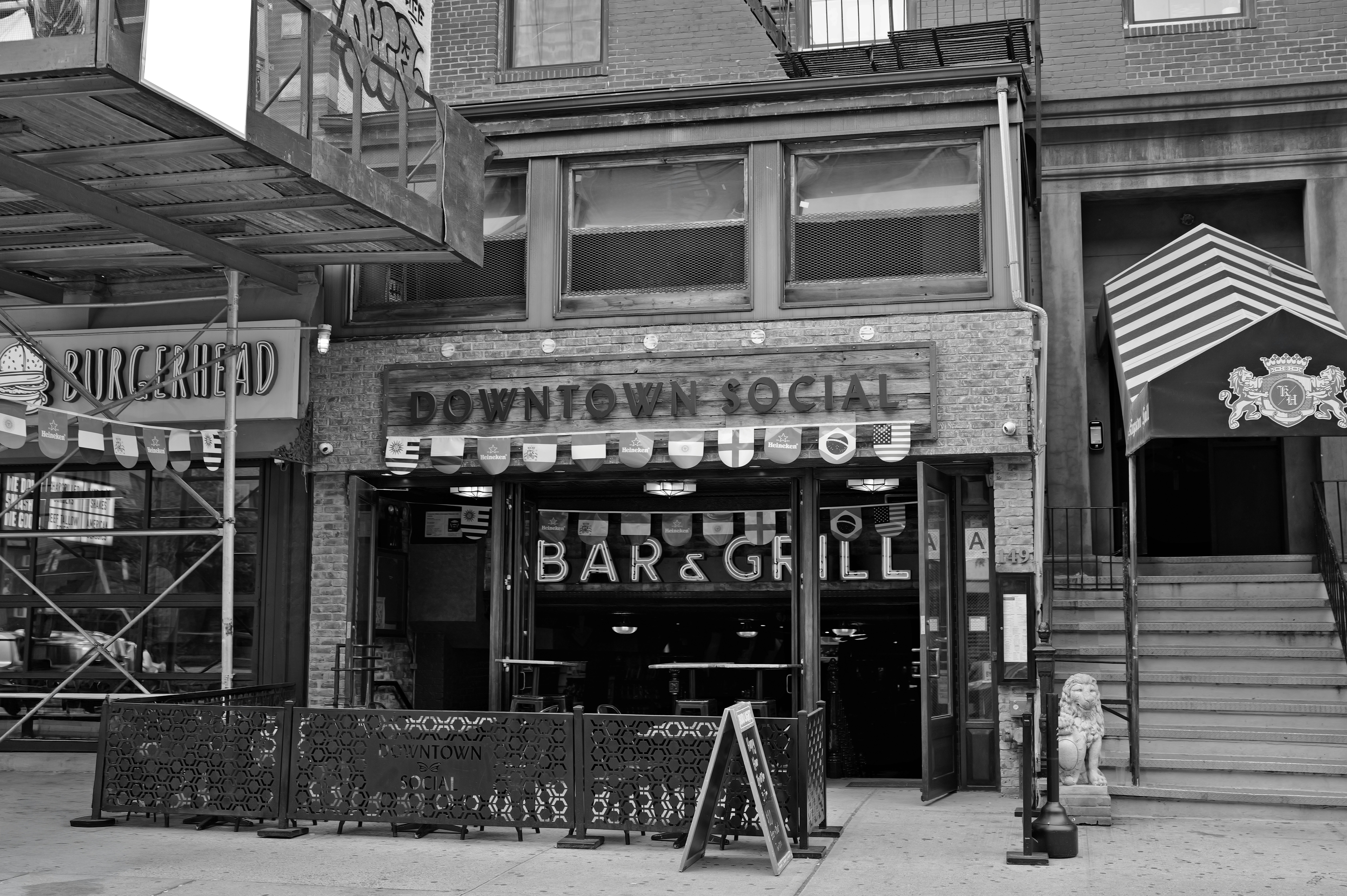 Downtown social bar & grill storefront in a city.