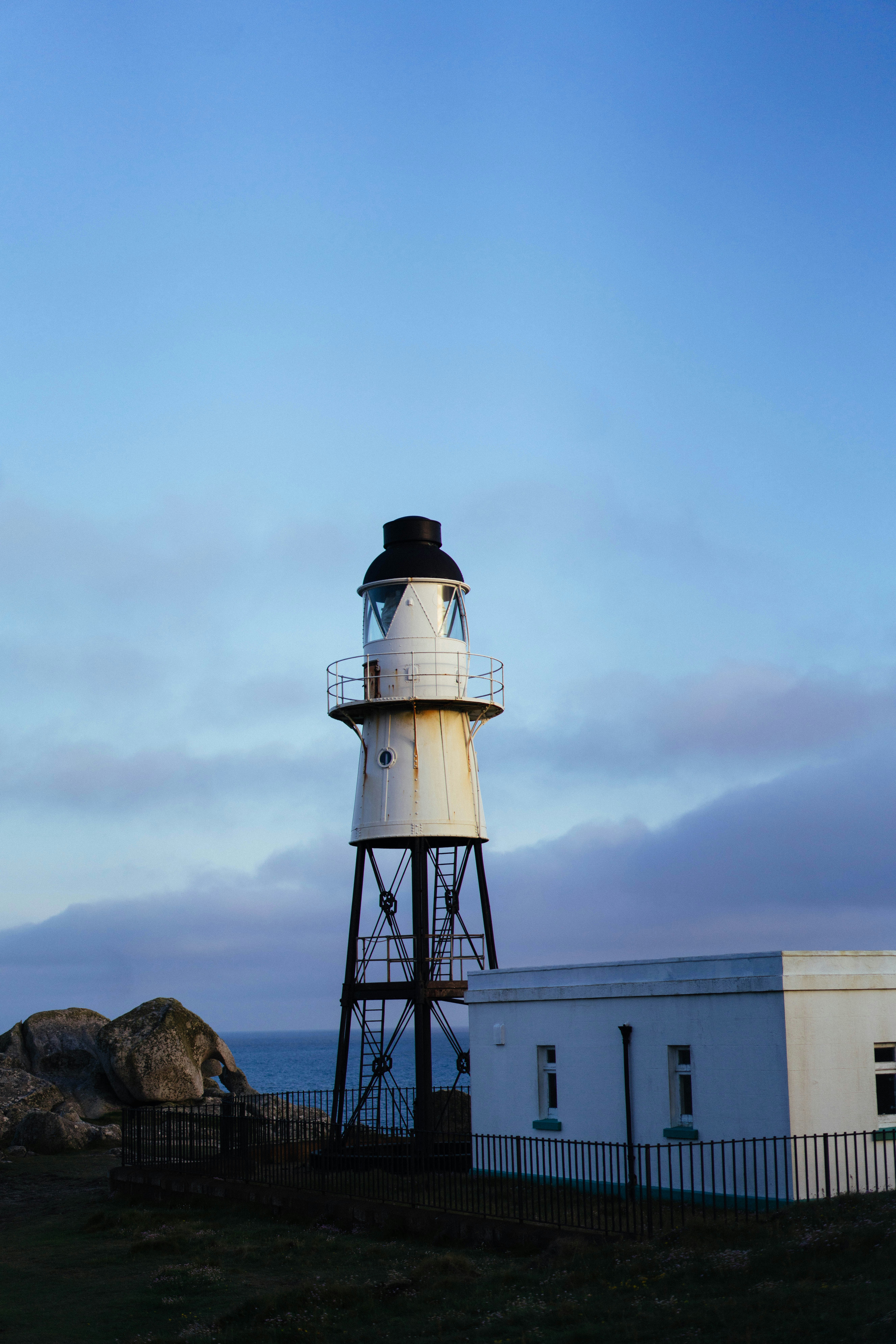 Beacon on the Edge: A Quiet Lighthouse Against a Coastal Sky
