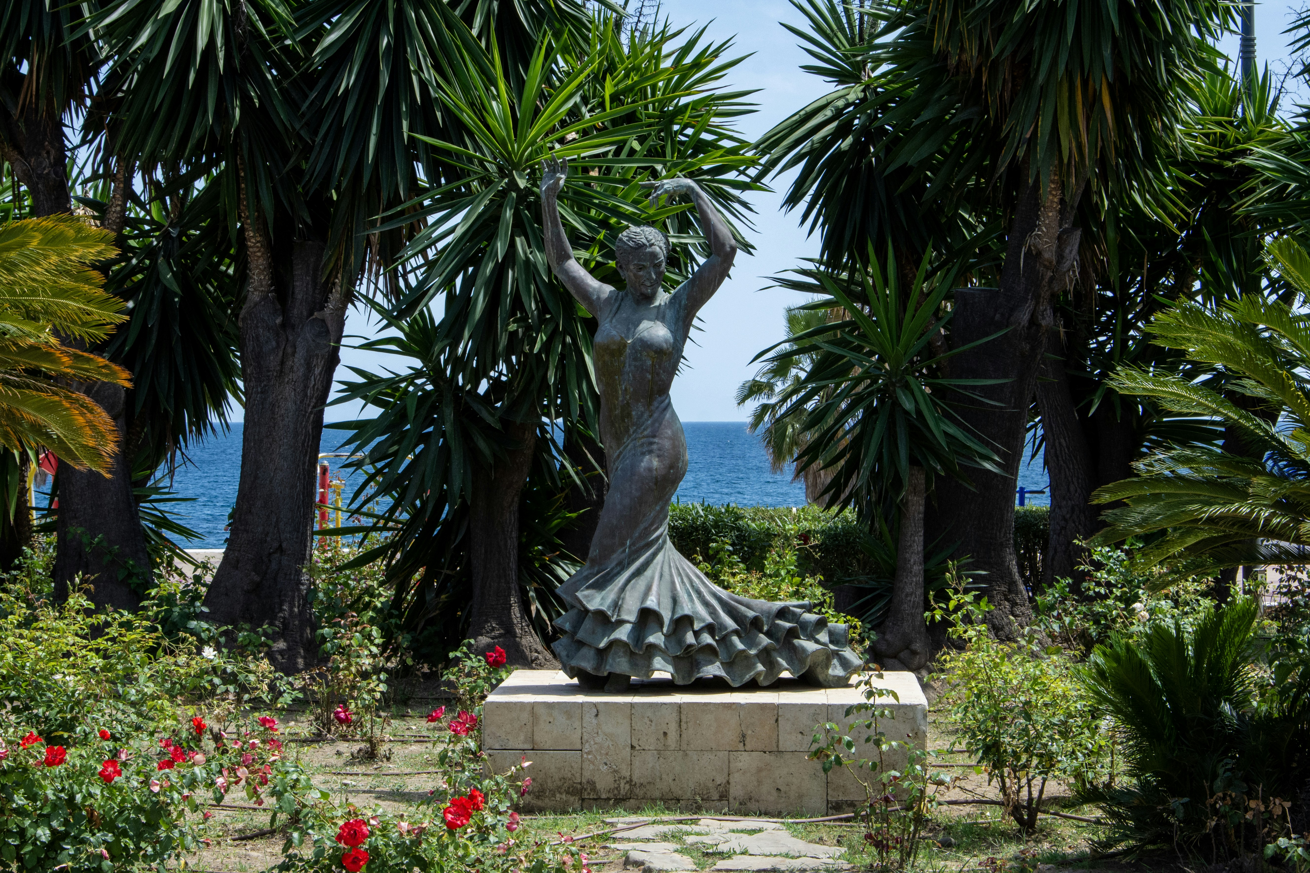 Statue of a Dancer Reaching Toward the Sea in a Mediterranean Garden