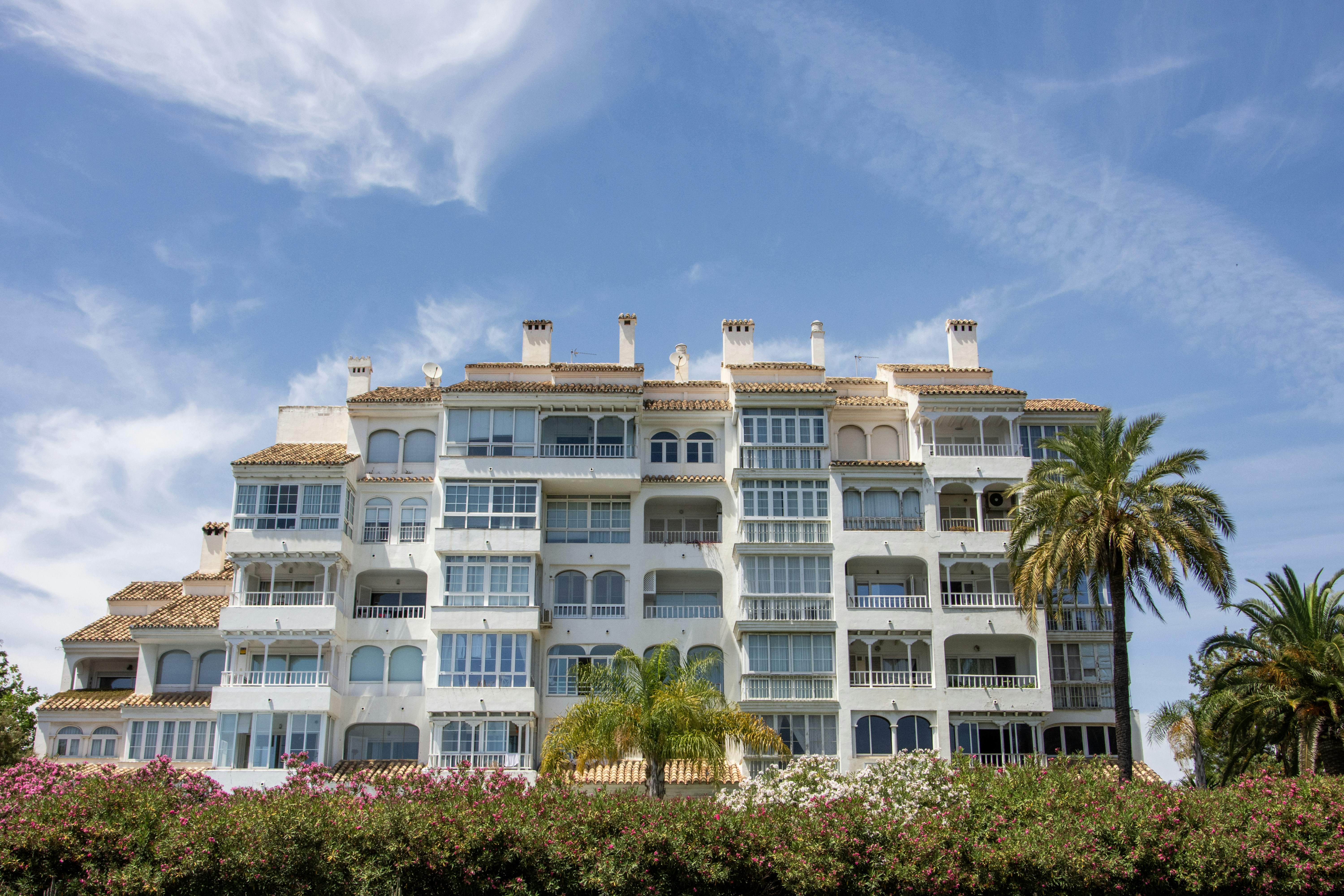 Coastal Villa Row: Sunlit Facades Against a Blue Sky