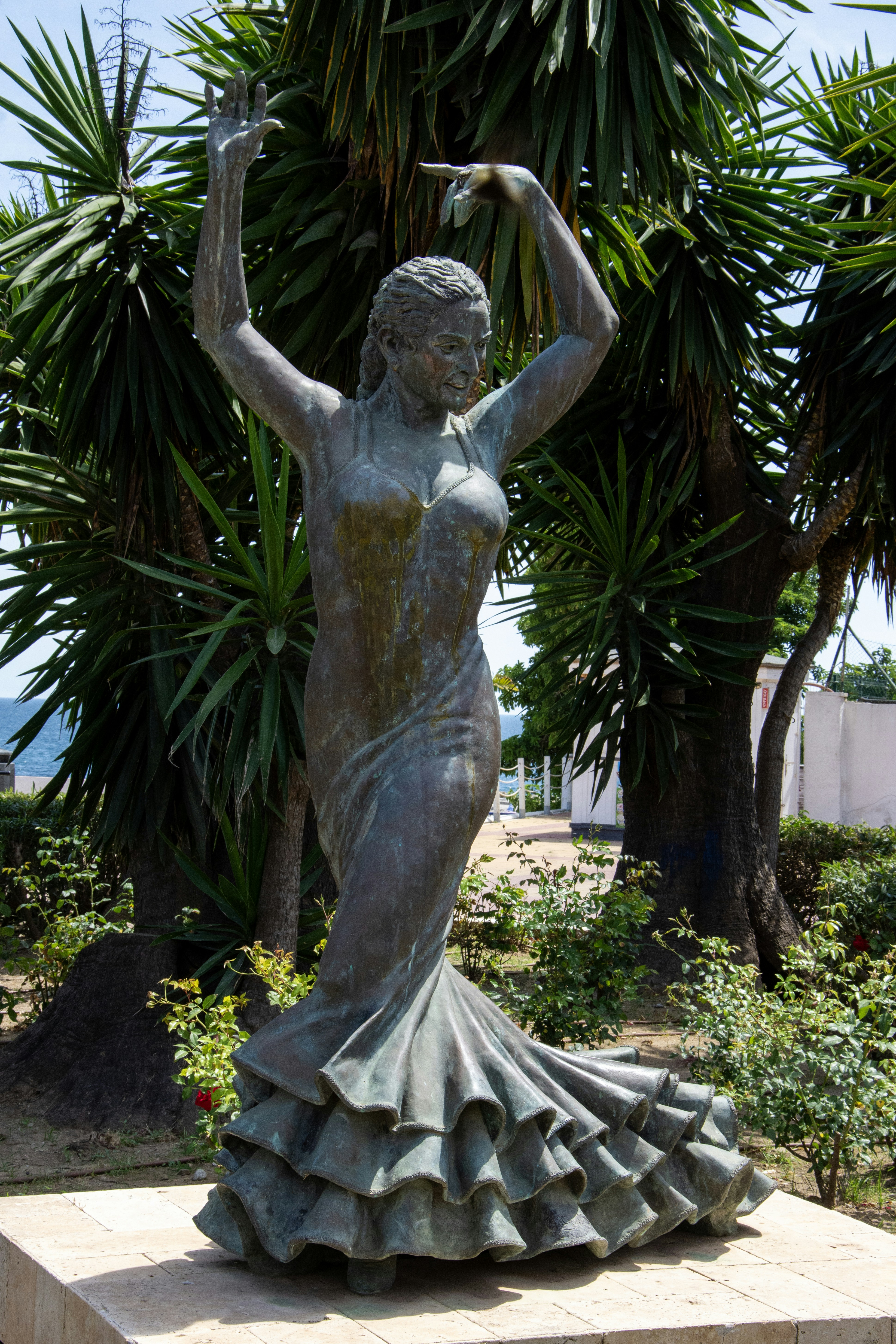 Dancing Bronze: a statue of a flamenco-inspired figure poised amidst tropical palms
