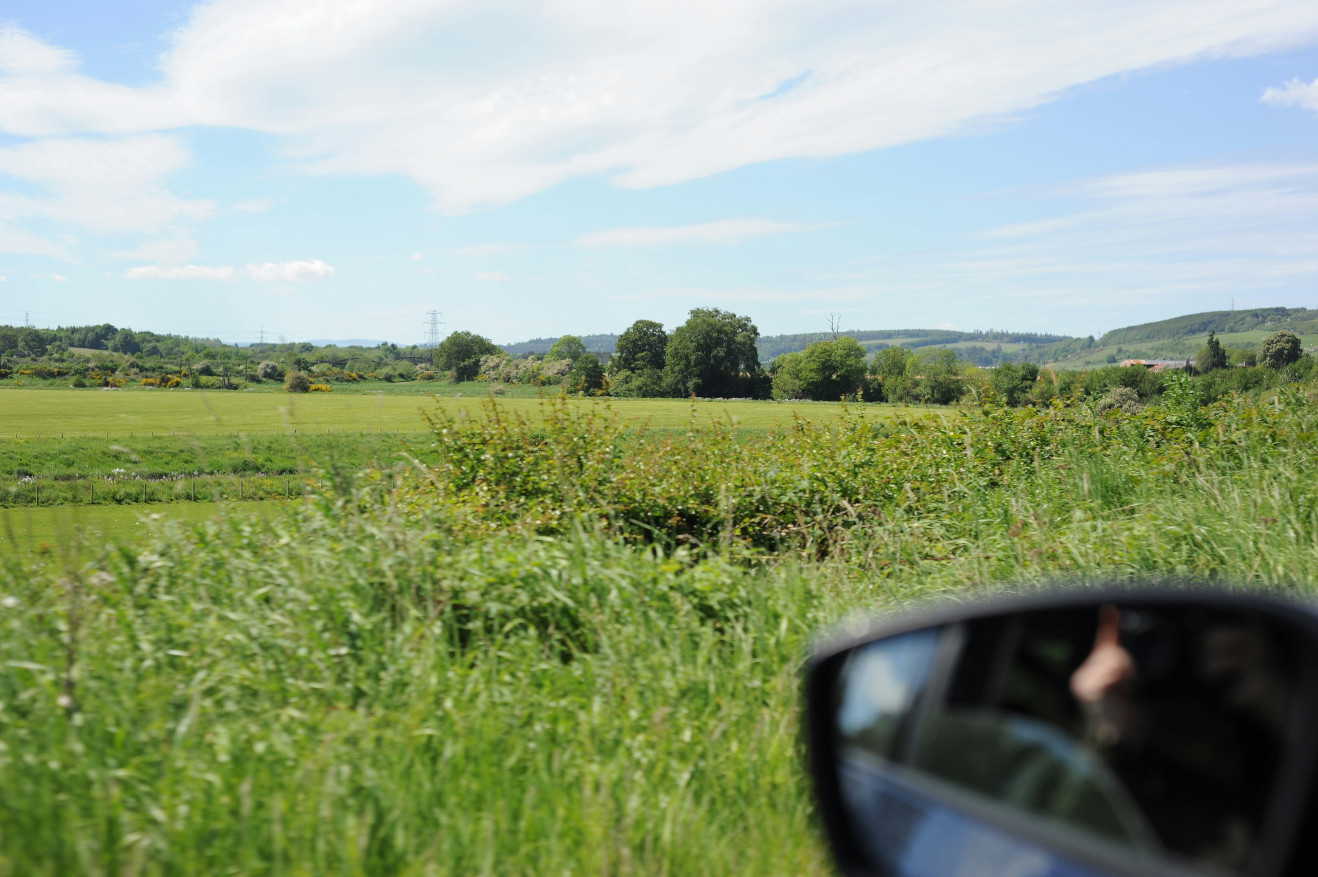 Rearview Reflections Over Open Fields