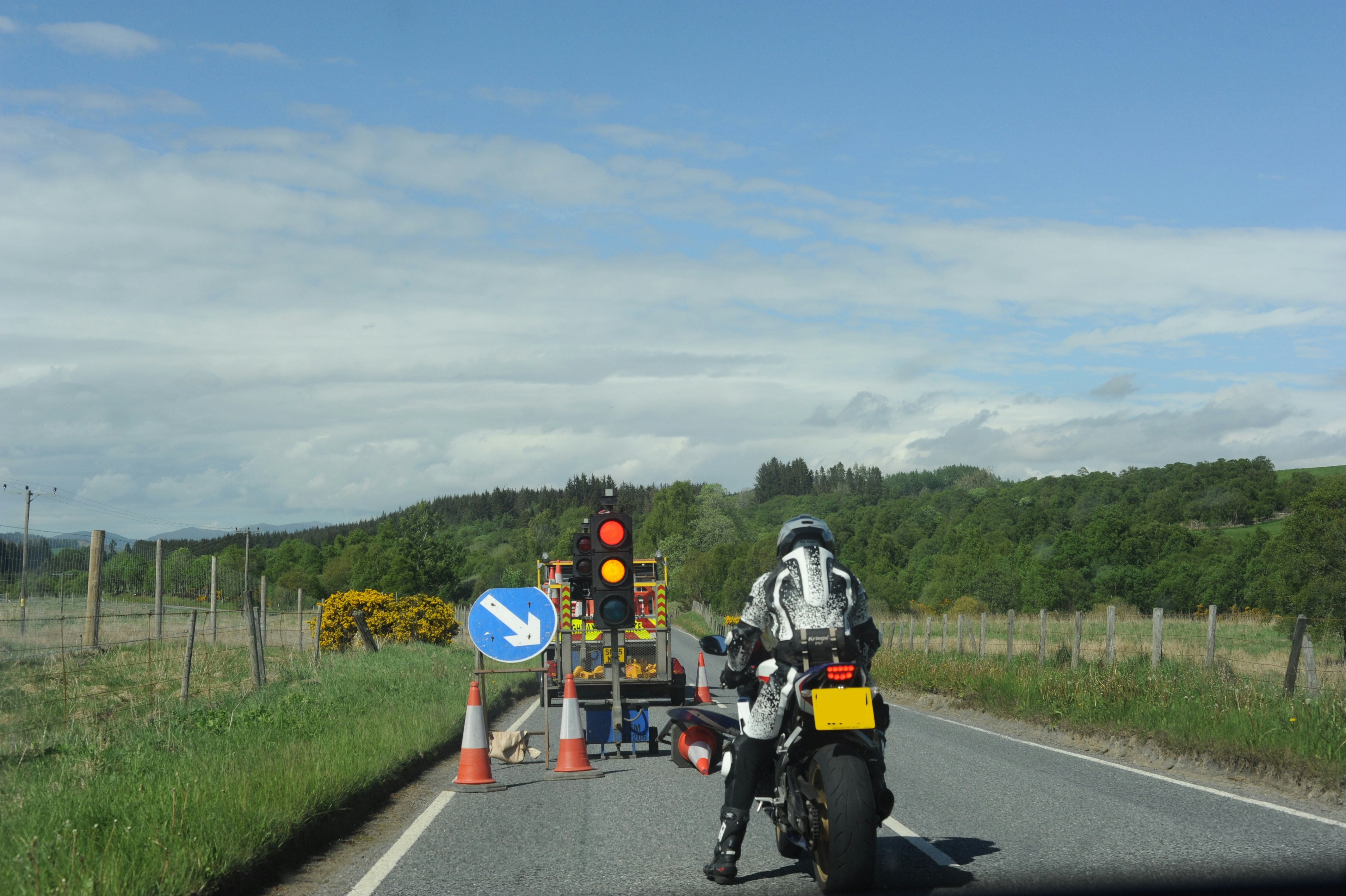 On-Route Signal: Rider Approaches a Roadwork Stoplight