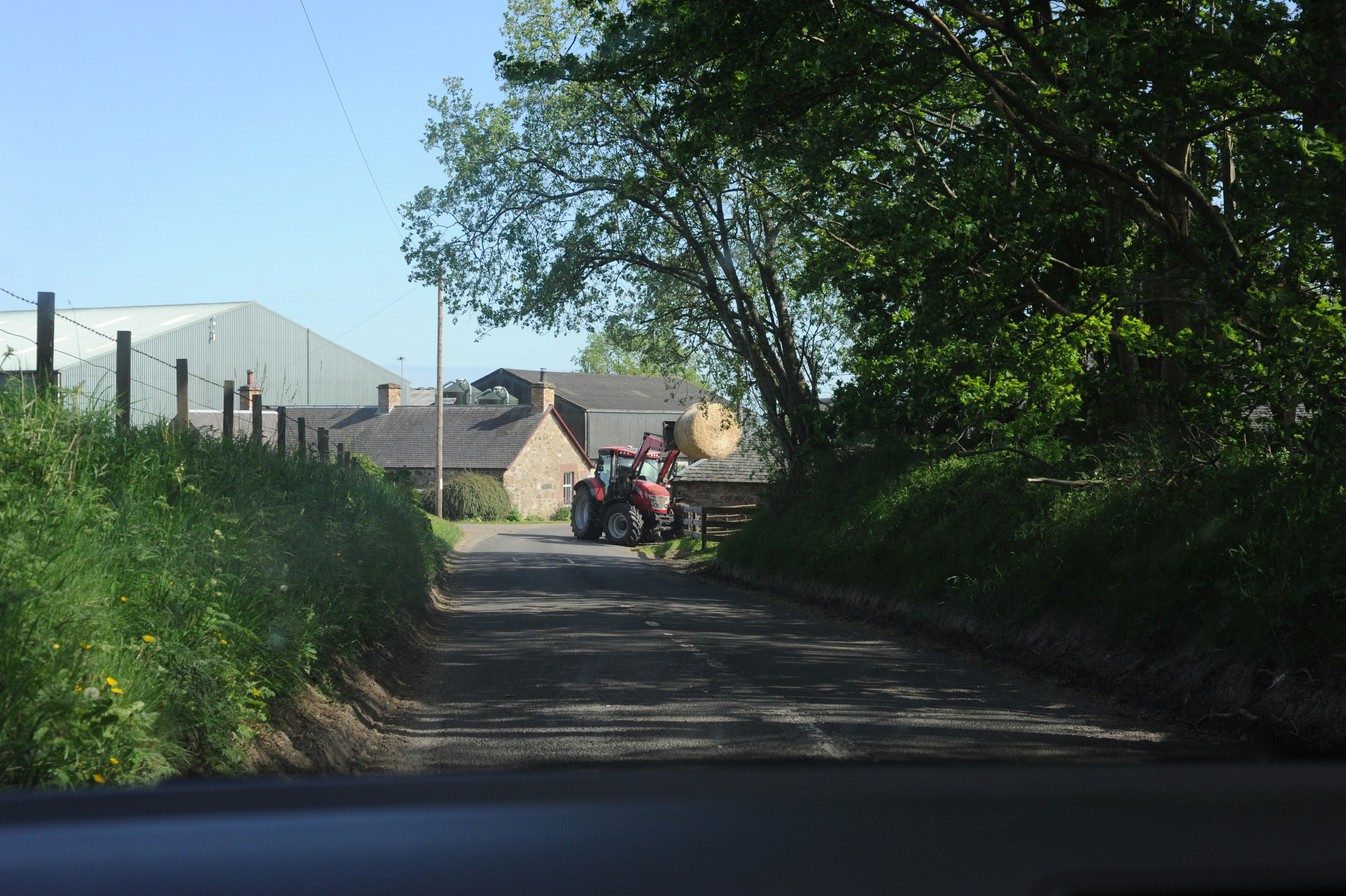 Red Tractor in the Dirt Road Clearing