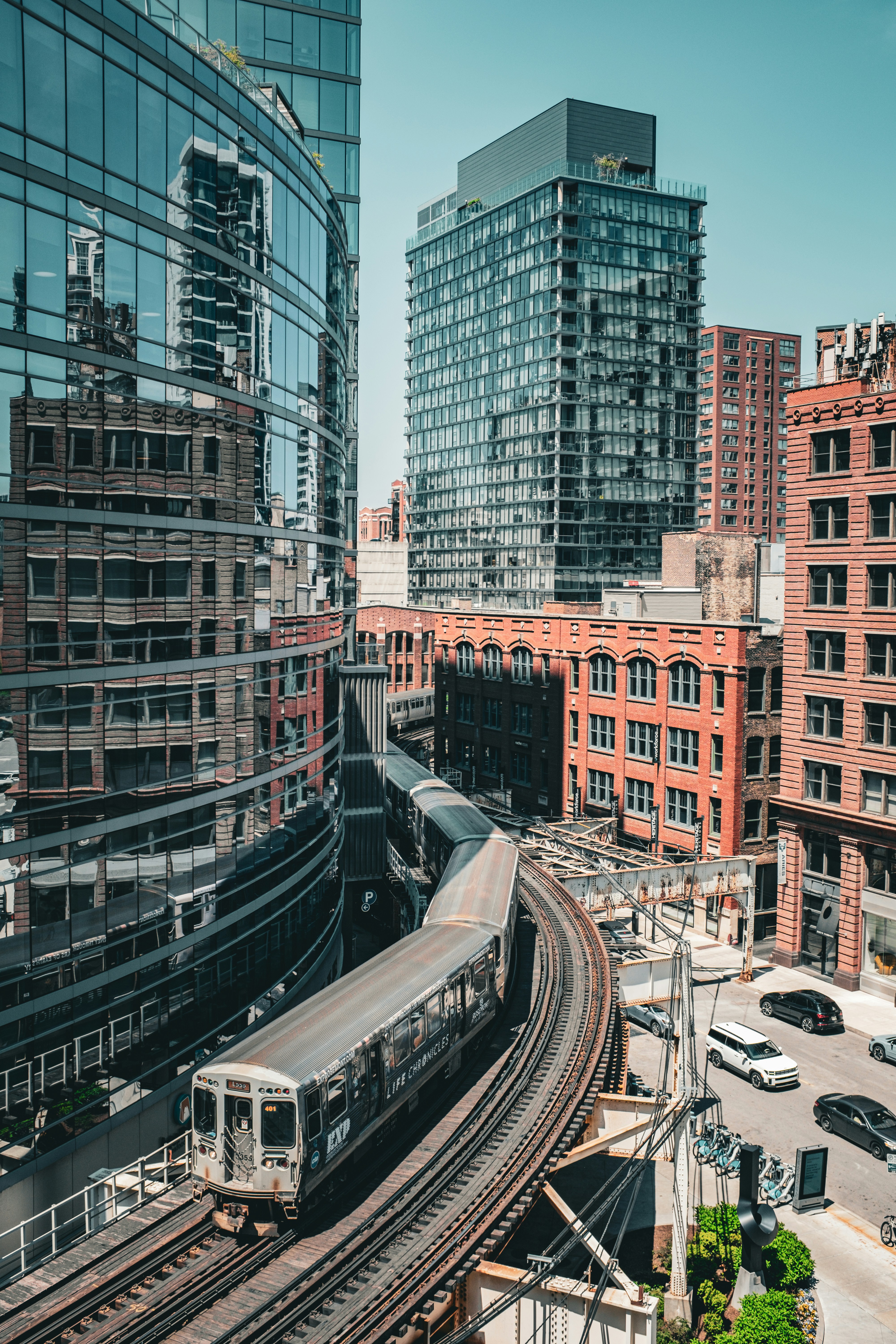 Skyward Rails: A City Train W winds Through Glass and Brick