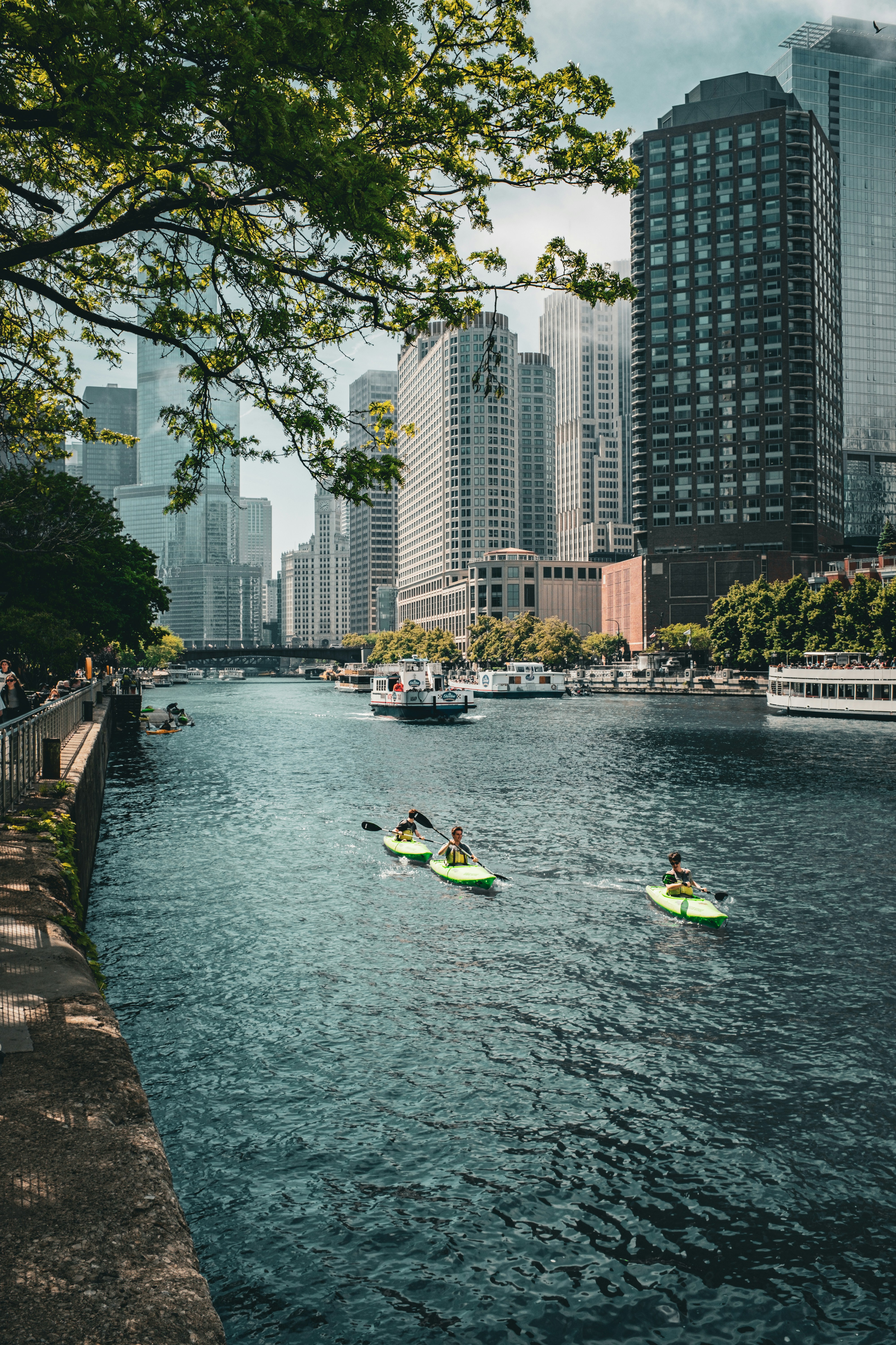 City-Chaise by the River: Kayaks Navigate a Skyscraper Corridor