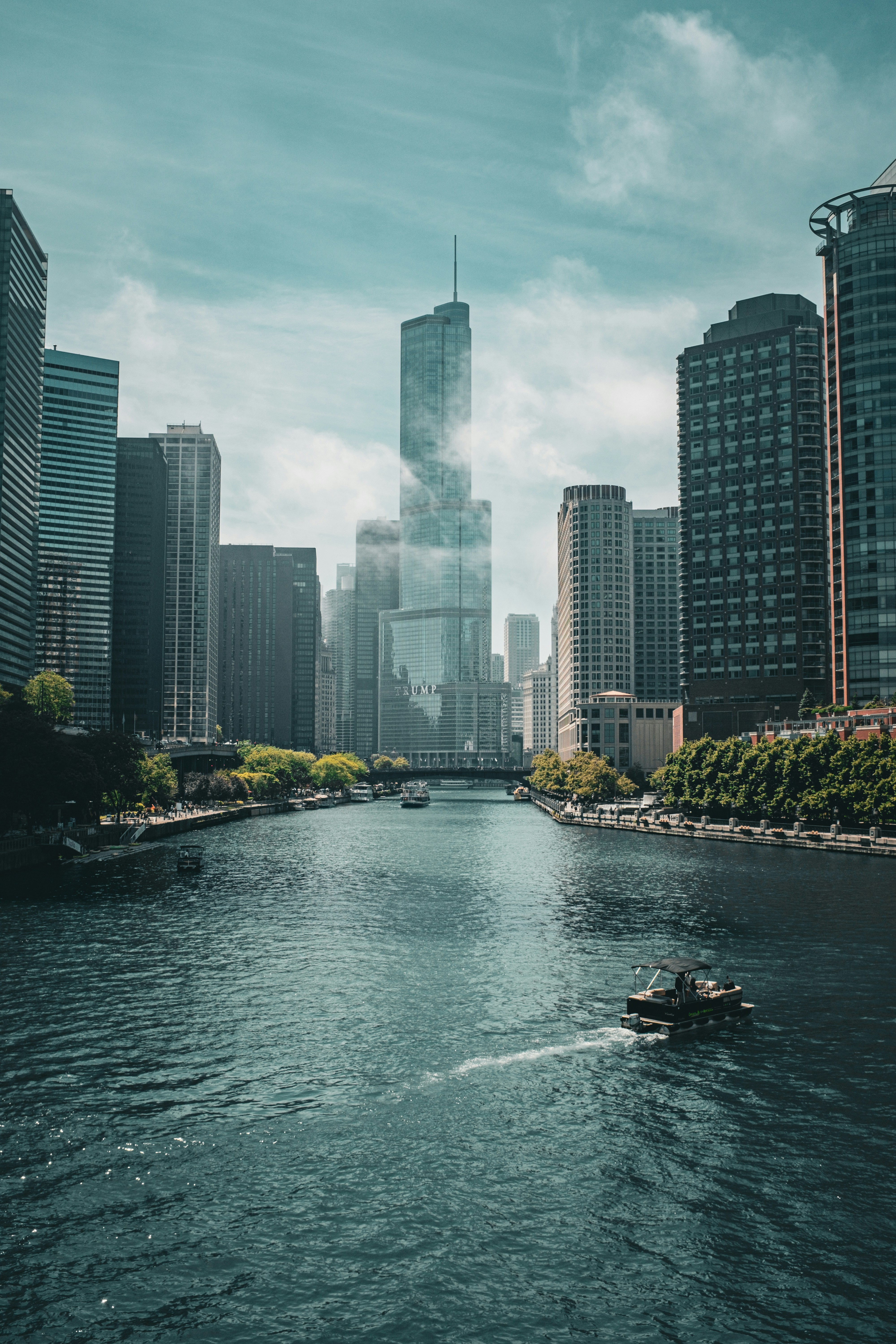 Midday River Corridor: Skyscrapers Framing a Calm Waterway