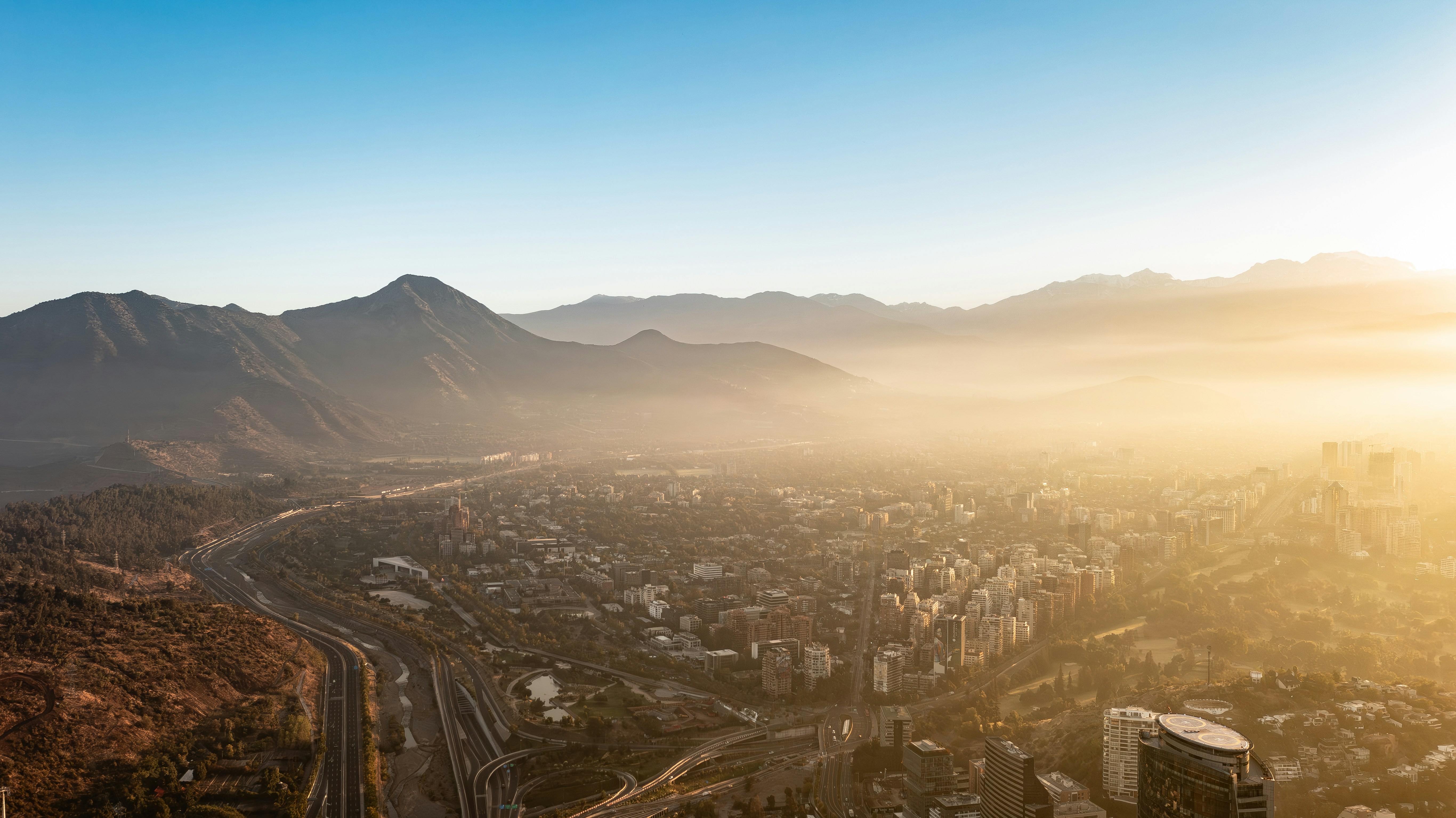 Golden Basin at Dusk: A Valley Waking Under Mountain Veils