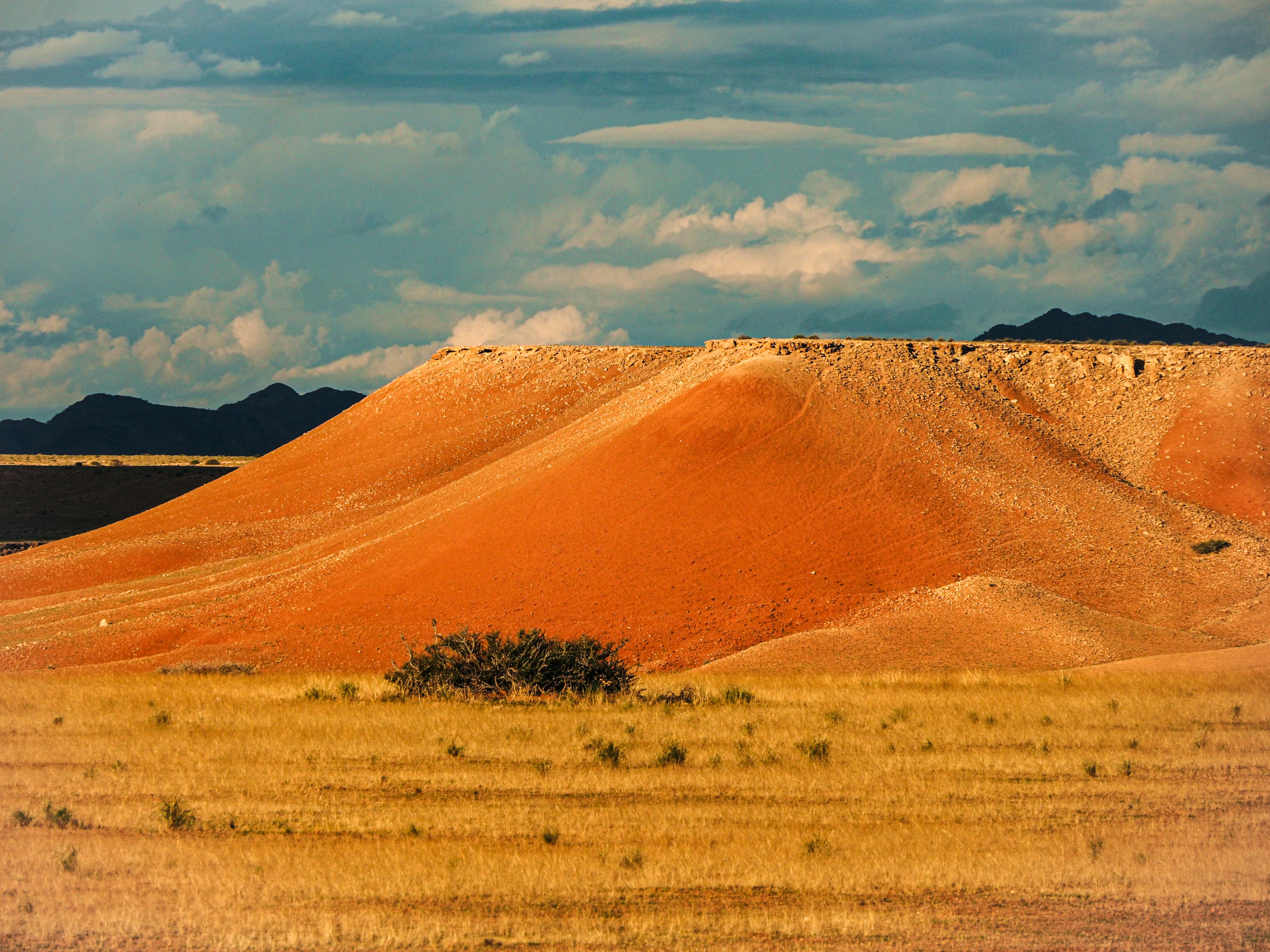 Rufous Hills under a Sky of Quiet Drama