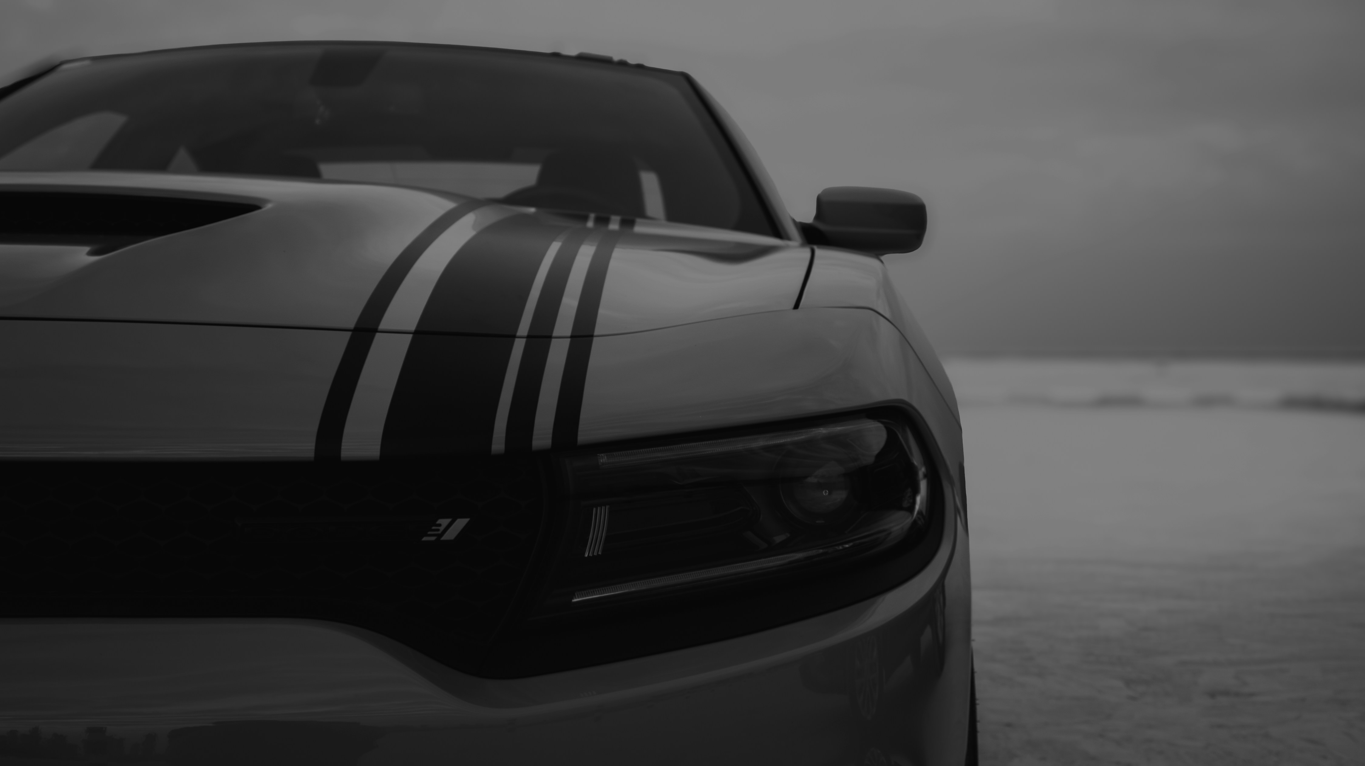 Racing Accent: A Front-Quarter of a Striped Muscle Car